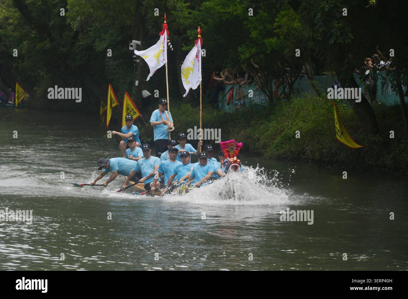 Locals row a traditional dragon boat in a race in the Xixi Wetland in ...