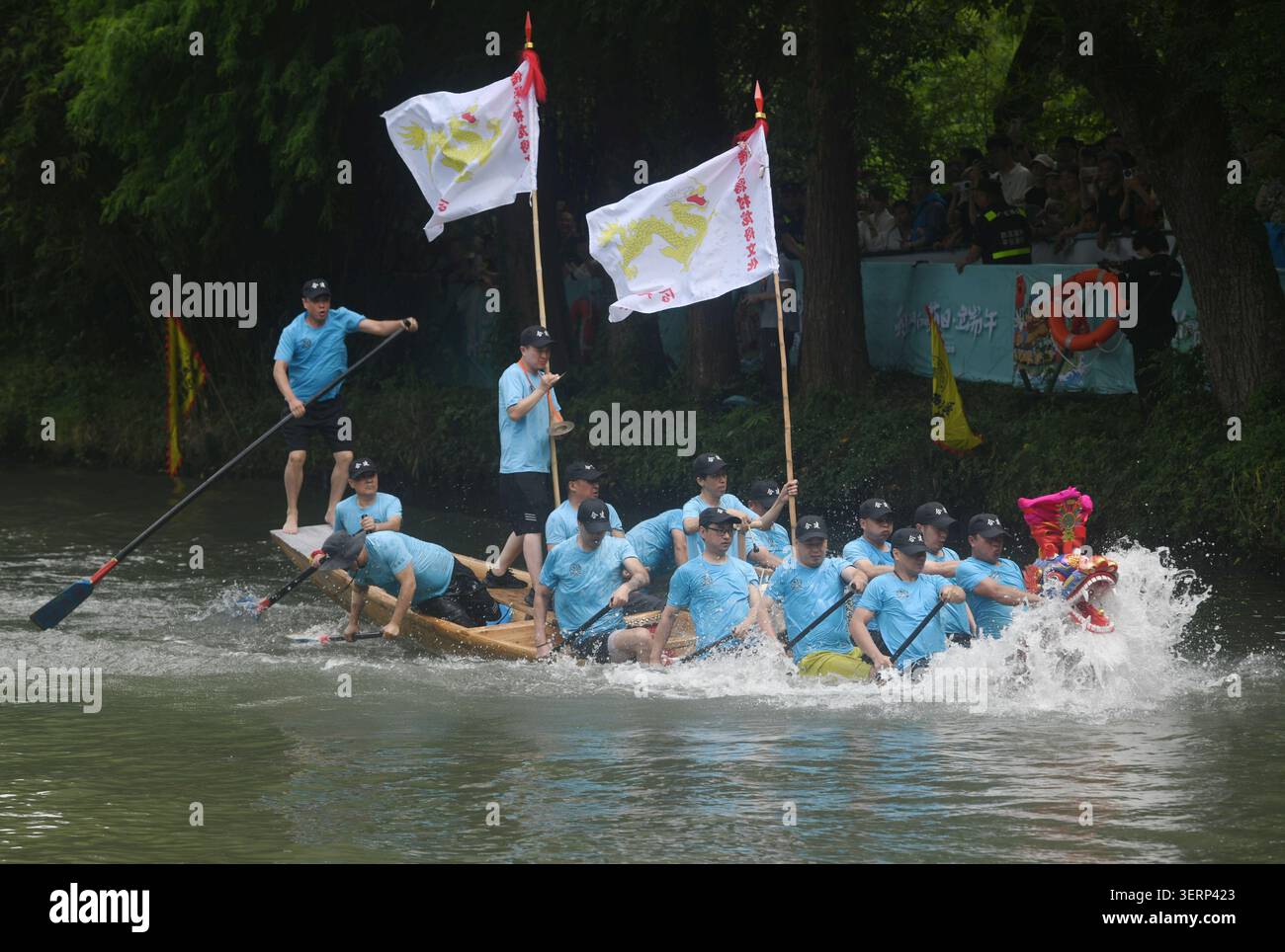 Locals row a traditional dragon boat in a race in the Xixi Wetland in ...