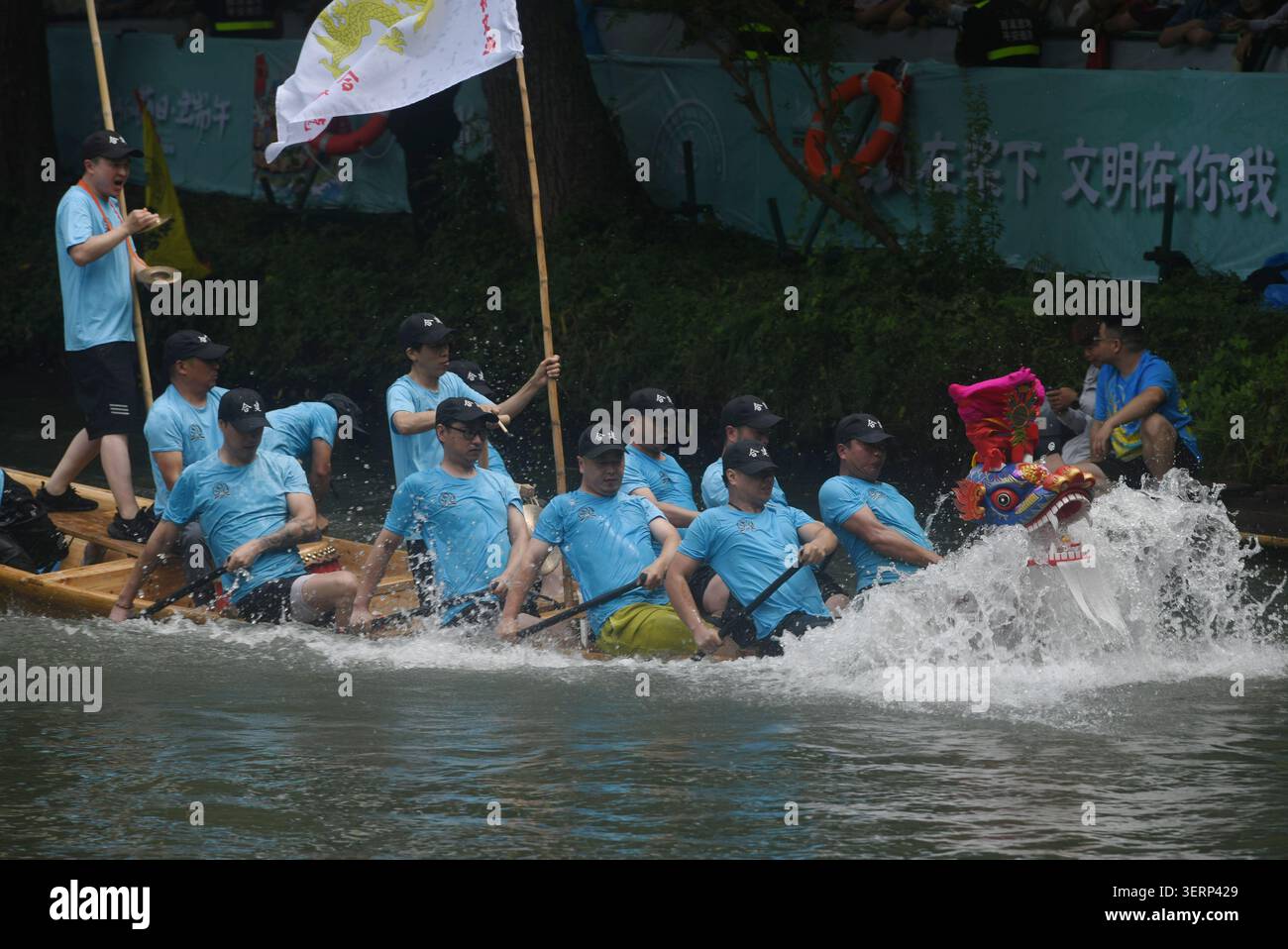 Locals row a traditional dragon boat in a race in the Xixi Wetland in ...