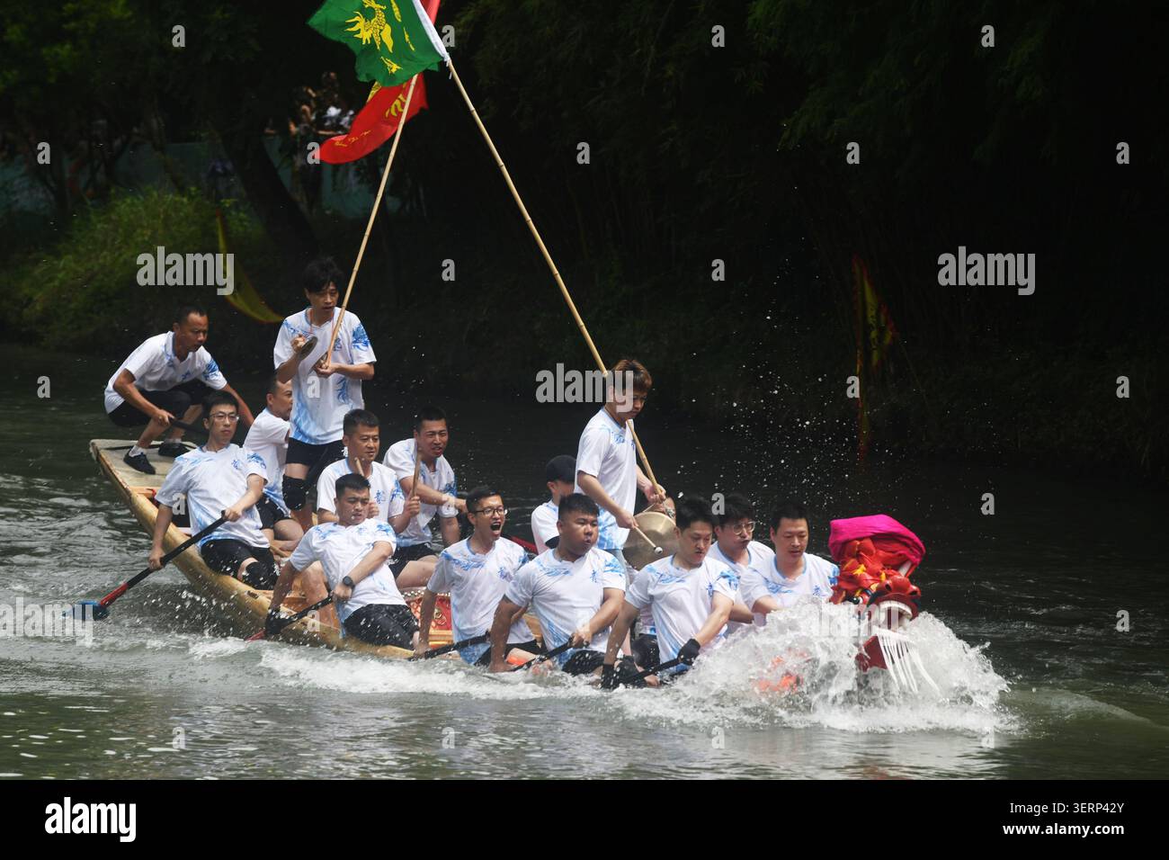 Locals row a traditional dragon boat in a race in the Xixi Wetland in ...