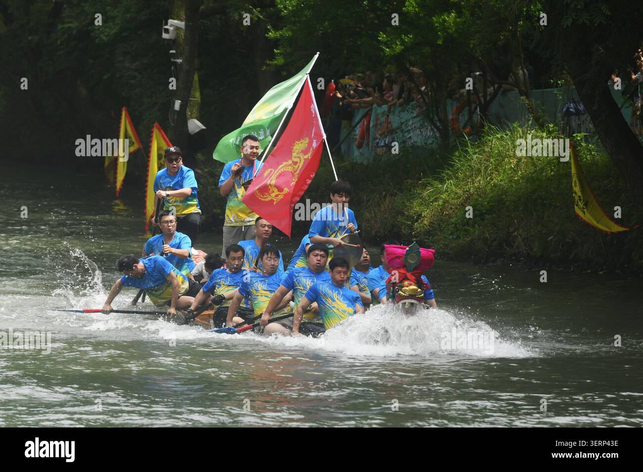 Locals row a traditional dragon boat in a race in the Xixi Wetland in ...