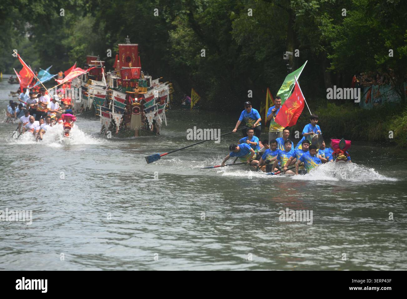 Locals row a traditional dragon boat in a race in the Xixi Wetland in ...