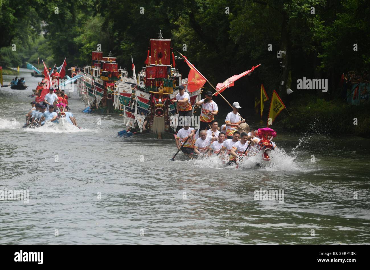 Locals row a traditional dragon boat in a race in the Xixi Wetland in ...