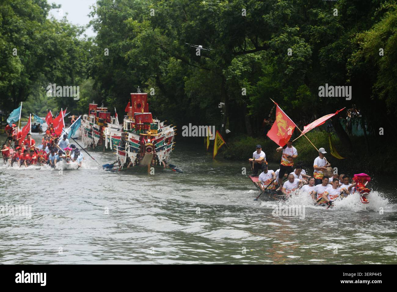 Locals row a traditional dragon boat in a race in the Xixi Wetland in ...