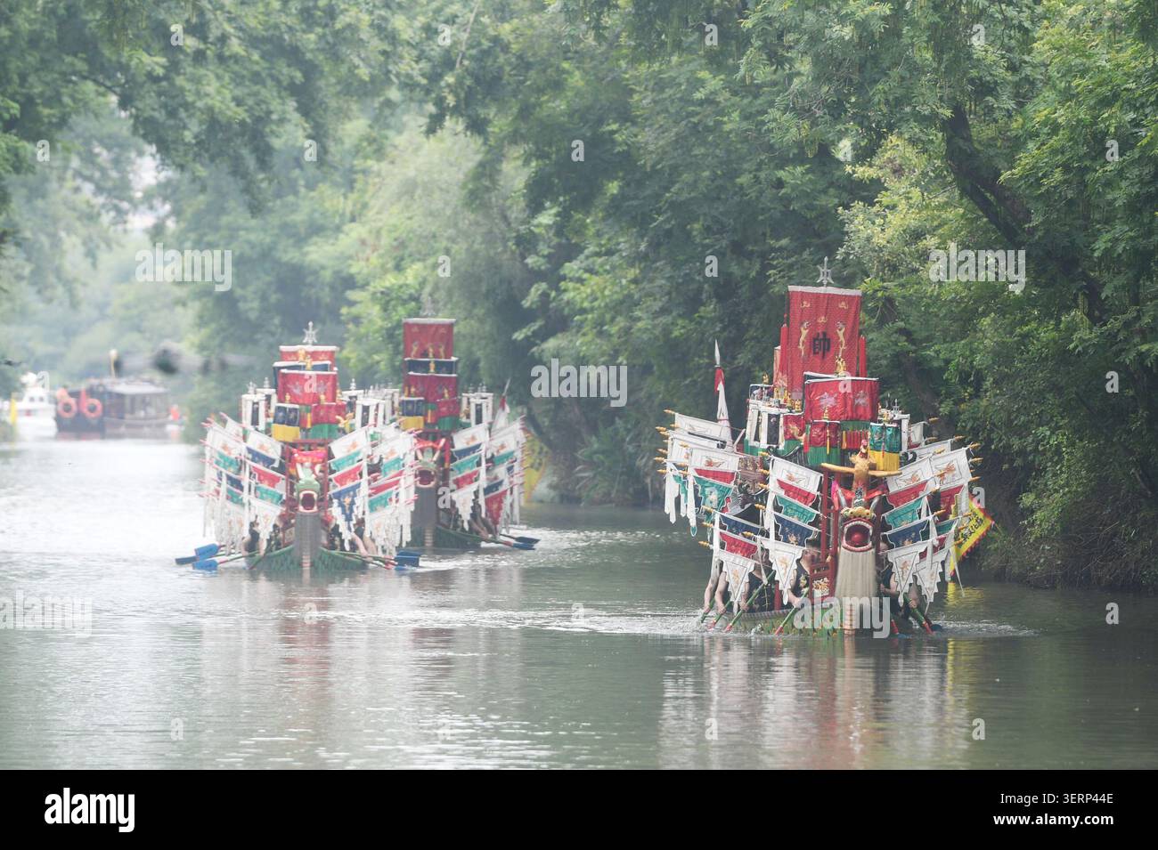 Locals row a traditional dragon boat in a race in the Xixi Wetland in ...