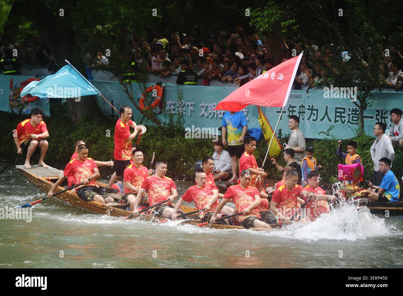 Locals row a traditional dragon boat in a race in the Xixi Wetland in ...