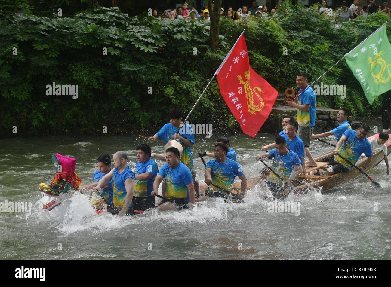 Locals row a traditional dragon boat in a race in the Xixi Wetland in ...