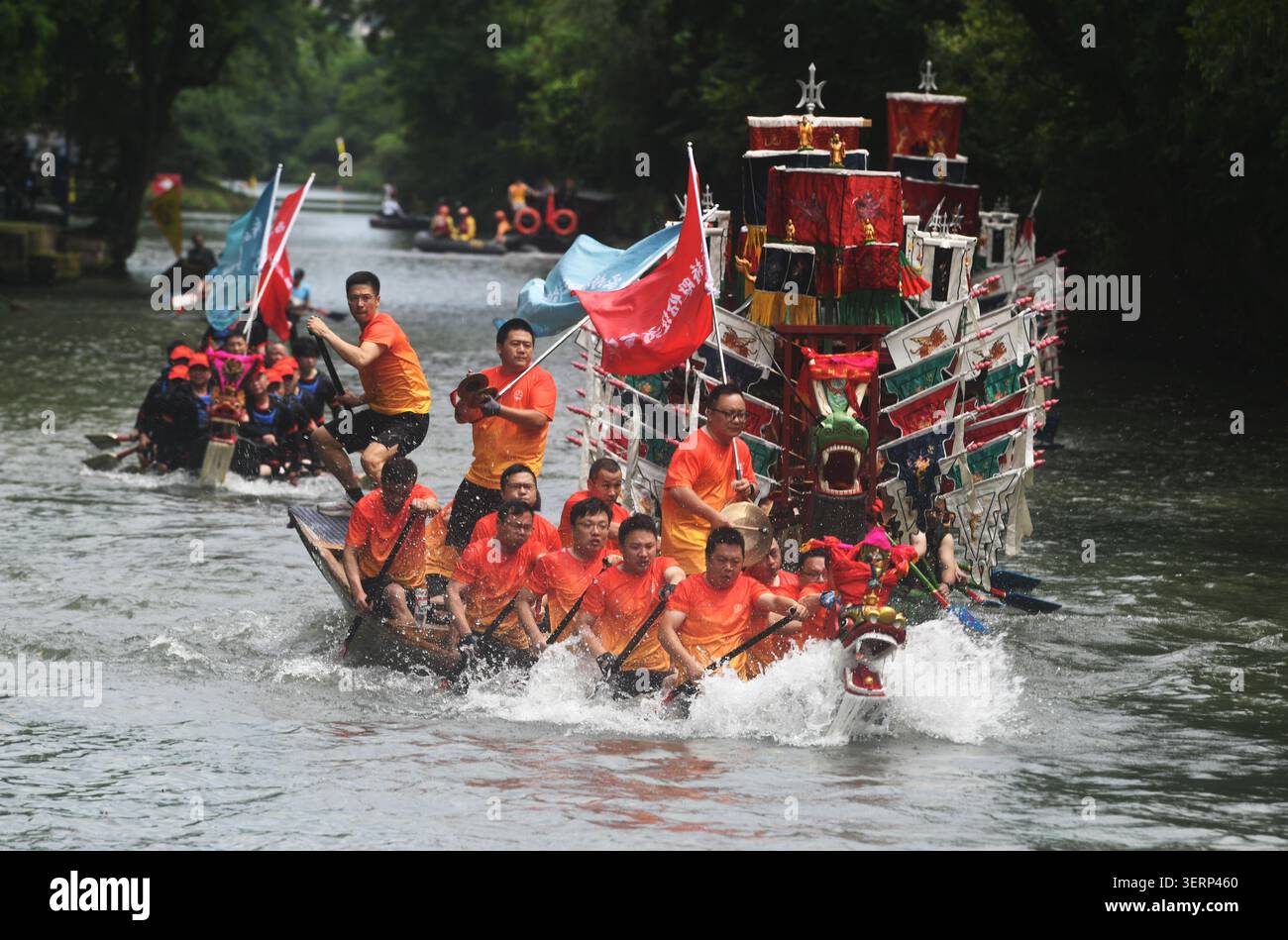 Locals row a traditional dragon boat in a race in the Xixi Wetland in ...