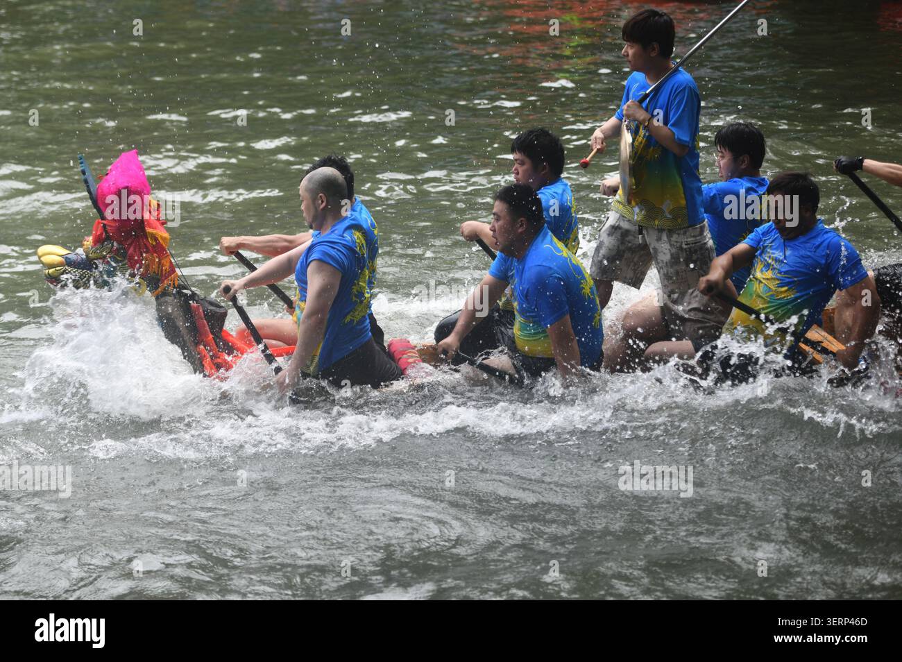 Locals row a traditional dragon boat in a race in the Xixi Wetland in ...