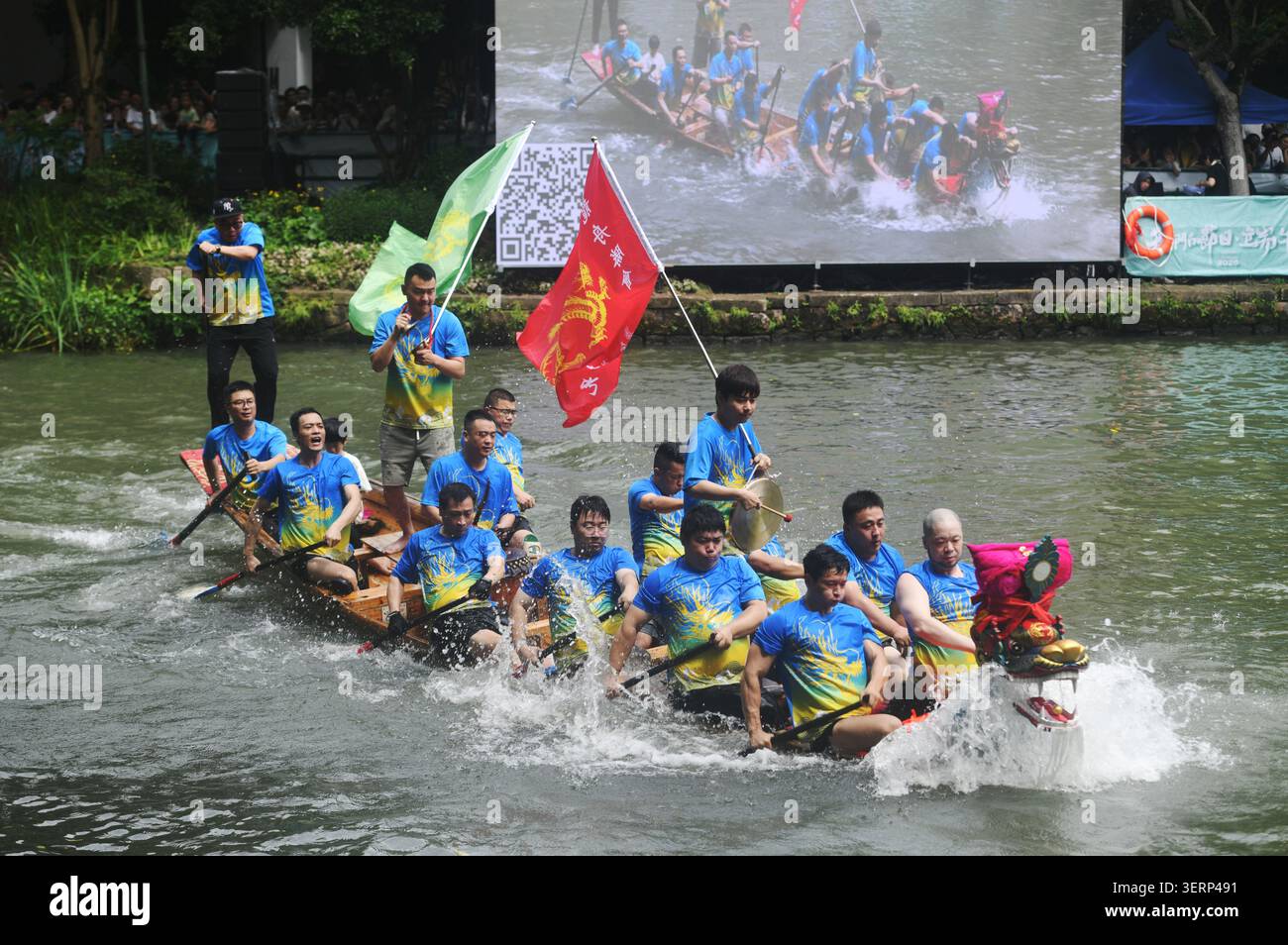 Locals row a traditional dragon boat in a race in the Xixi Wetland in ...