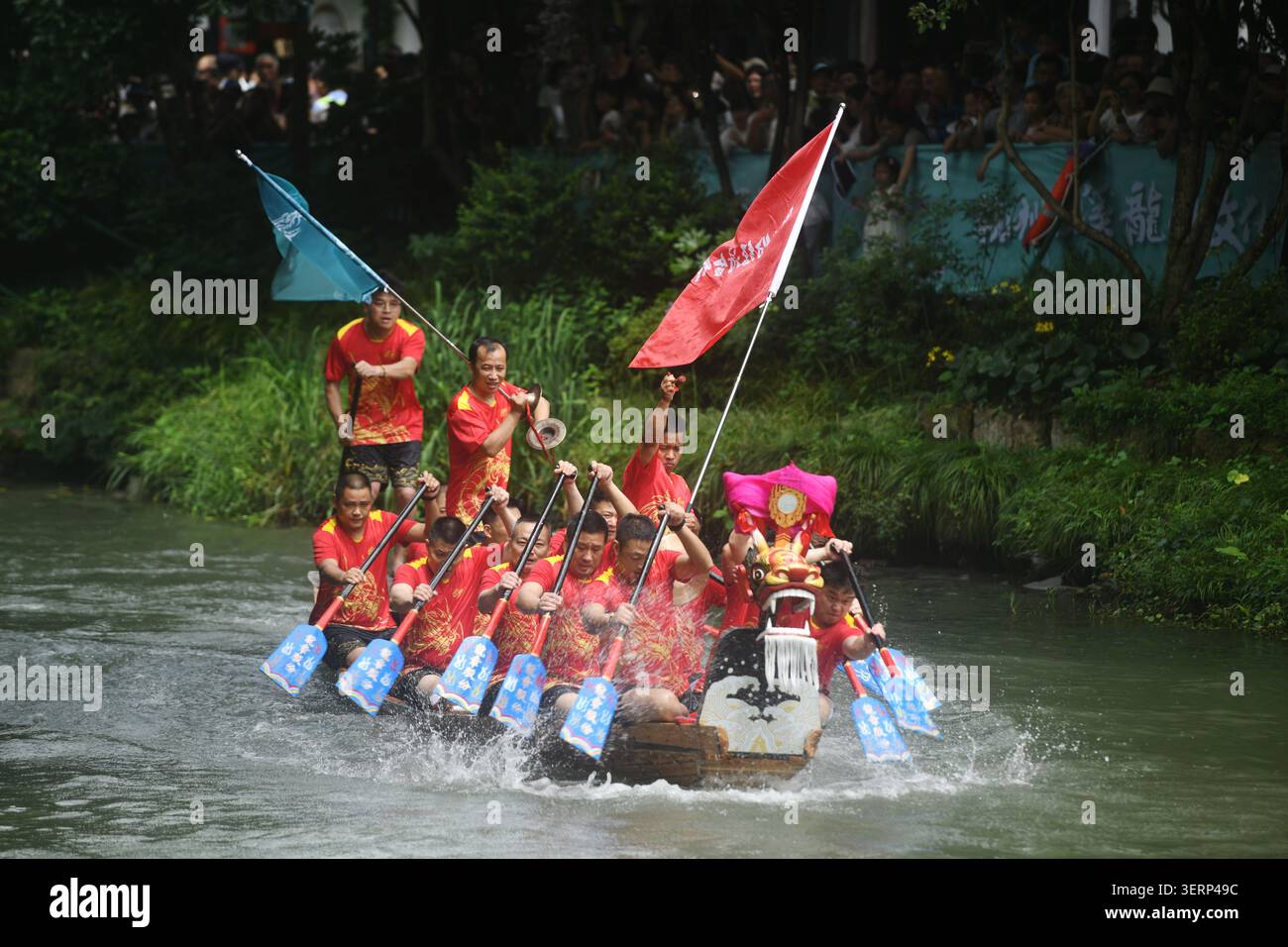 Locals row a traditional dragon boat in a race in the Xixi Wetland in ...