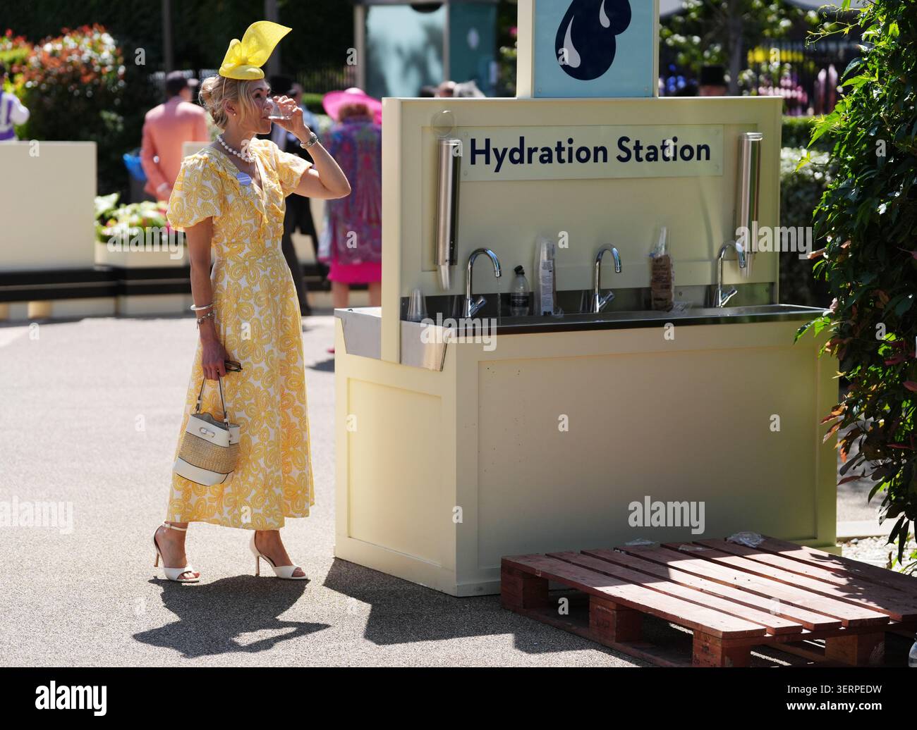 A racegoer drinks from a hydration station day four of Royal Ascot at ...