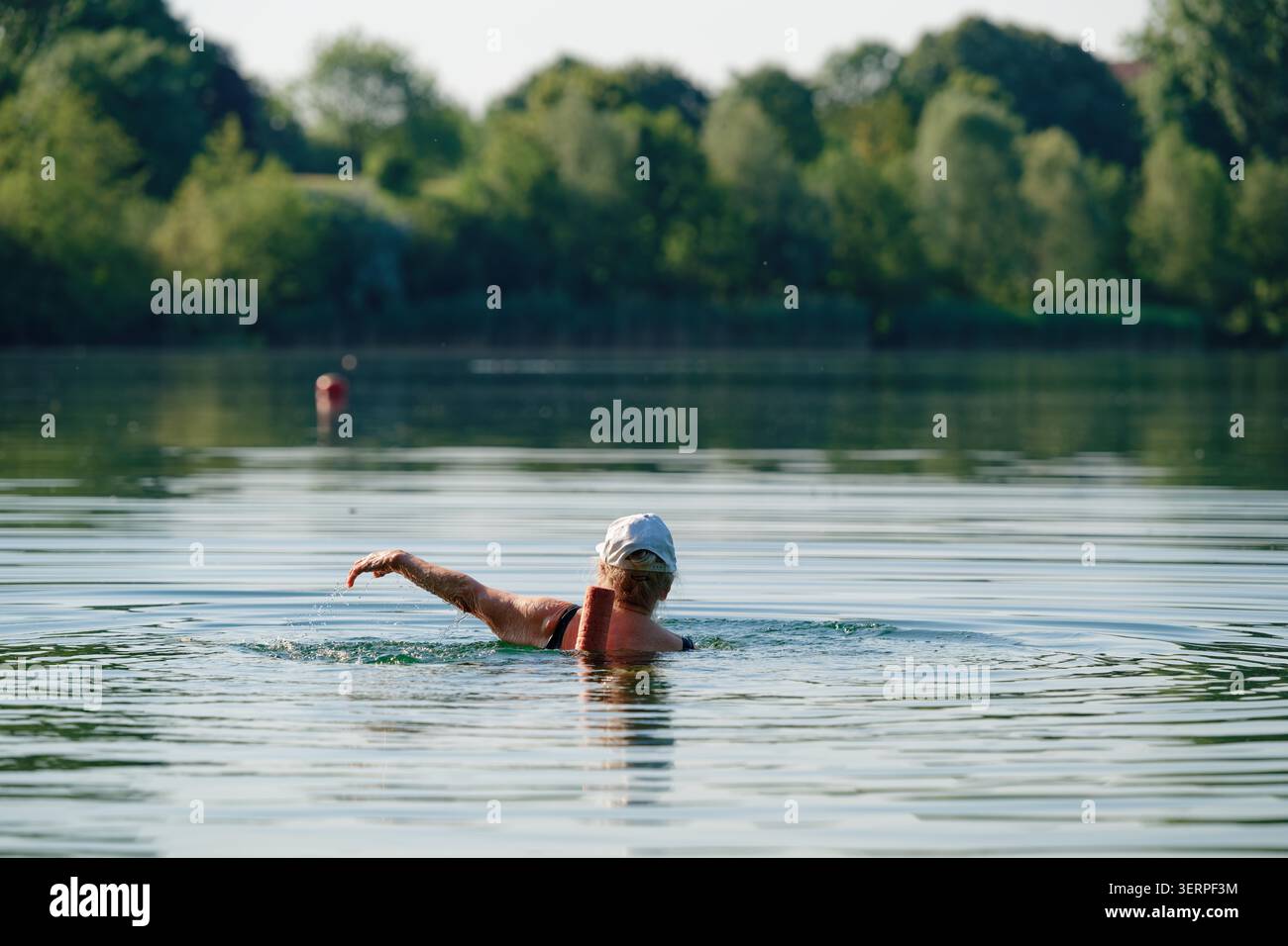 19 June 2026, Baden-Württemberg, Mannheim: A woman wearing a flotation ...