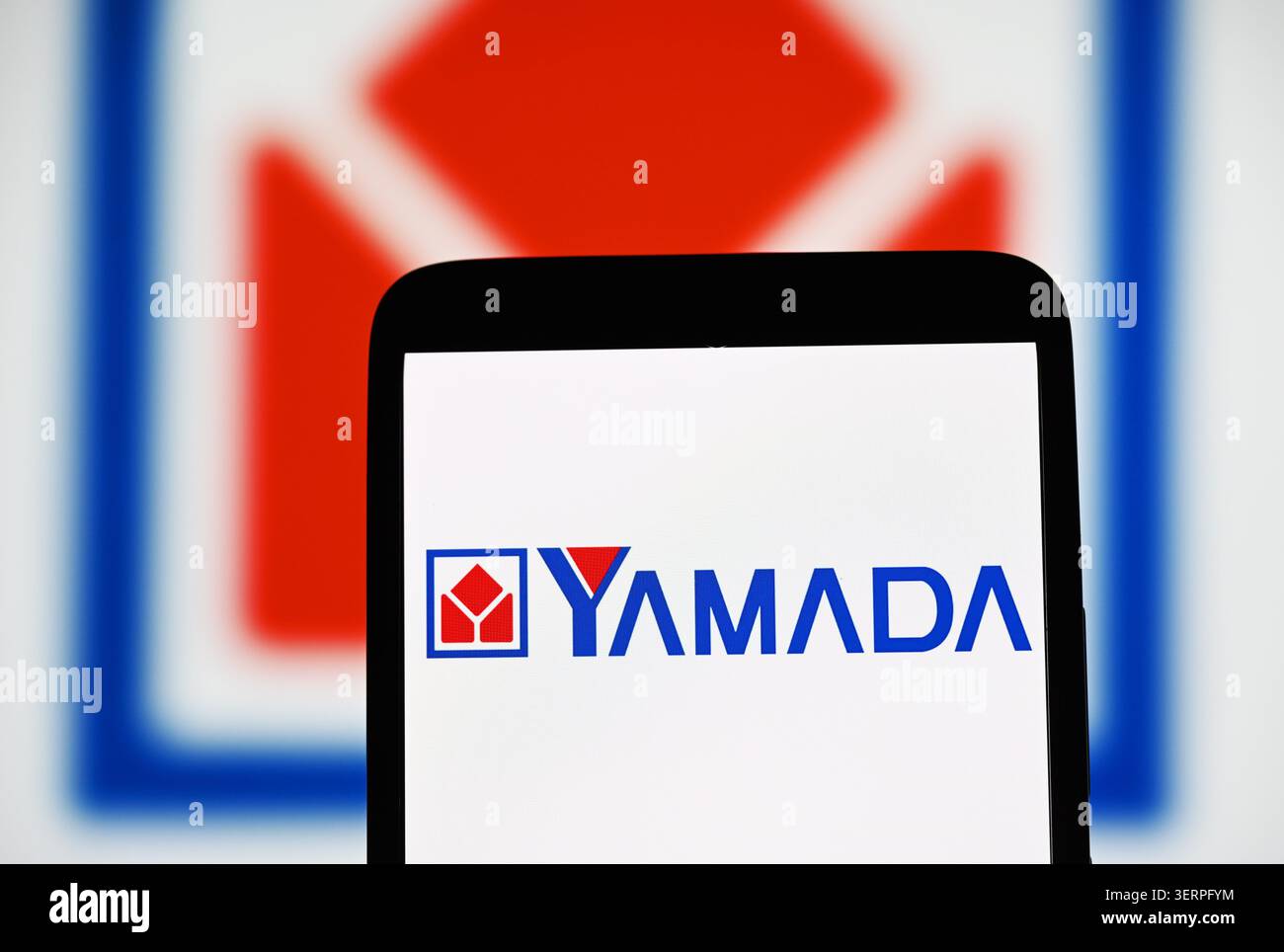 In this photo illustration, the Yamada Holdings logo is seen displayed ...