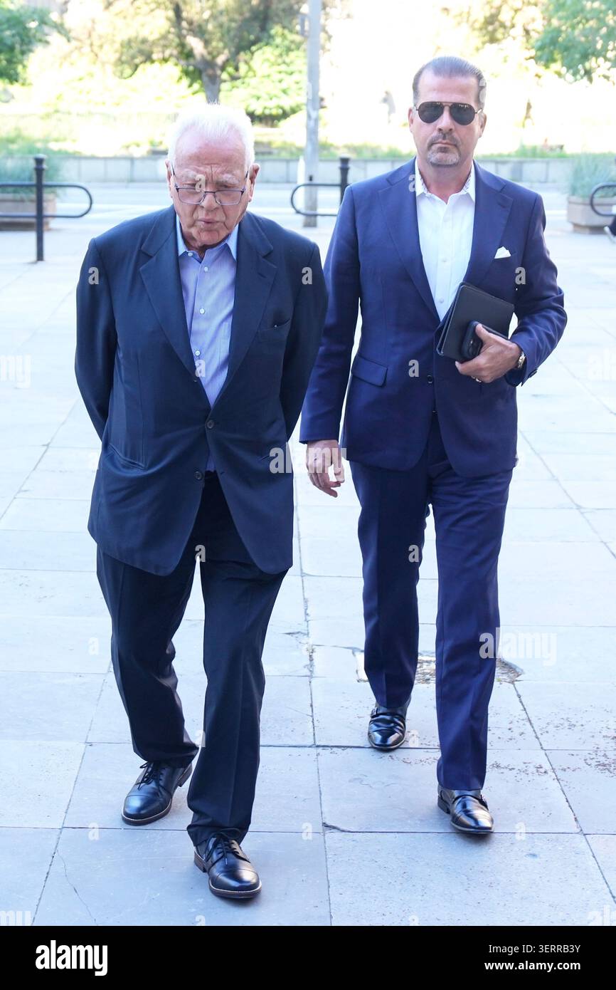 Frank Stronach, left, arrives at a Toronto court on Friday, June 19 ...