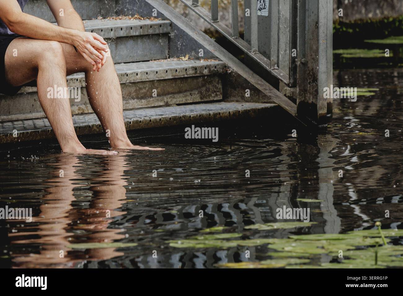 A man cools his feet in the Mueggelspree, taken in the district of ...