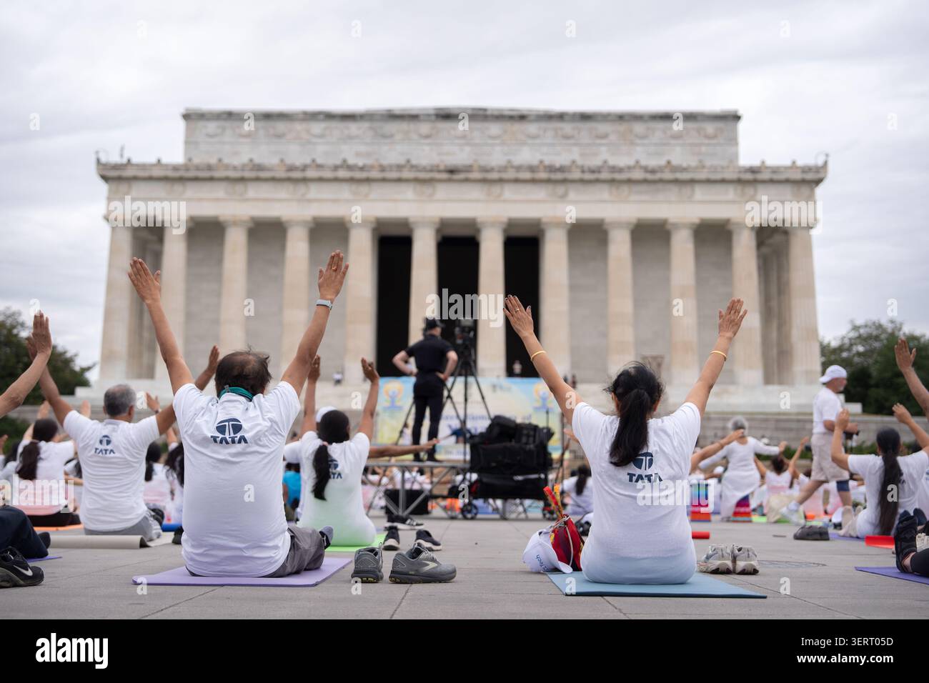 People perform yoga near the Lincoln Memorial as part of commemorations ...