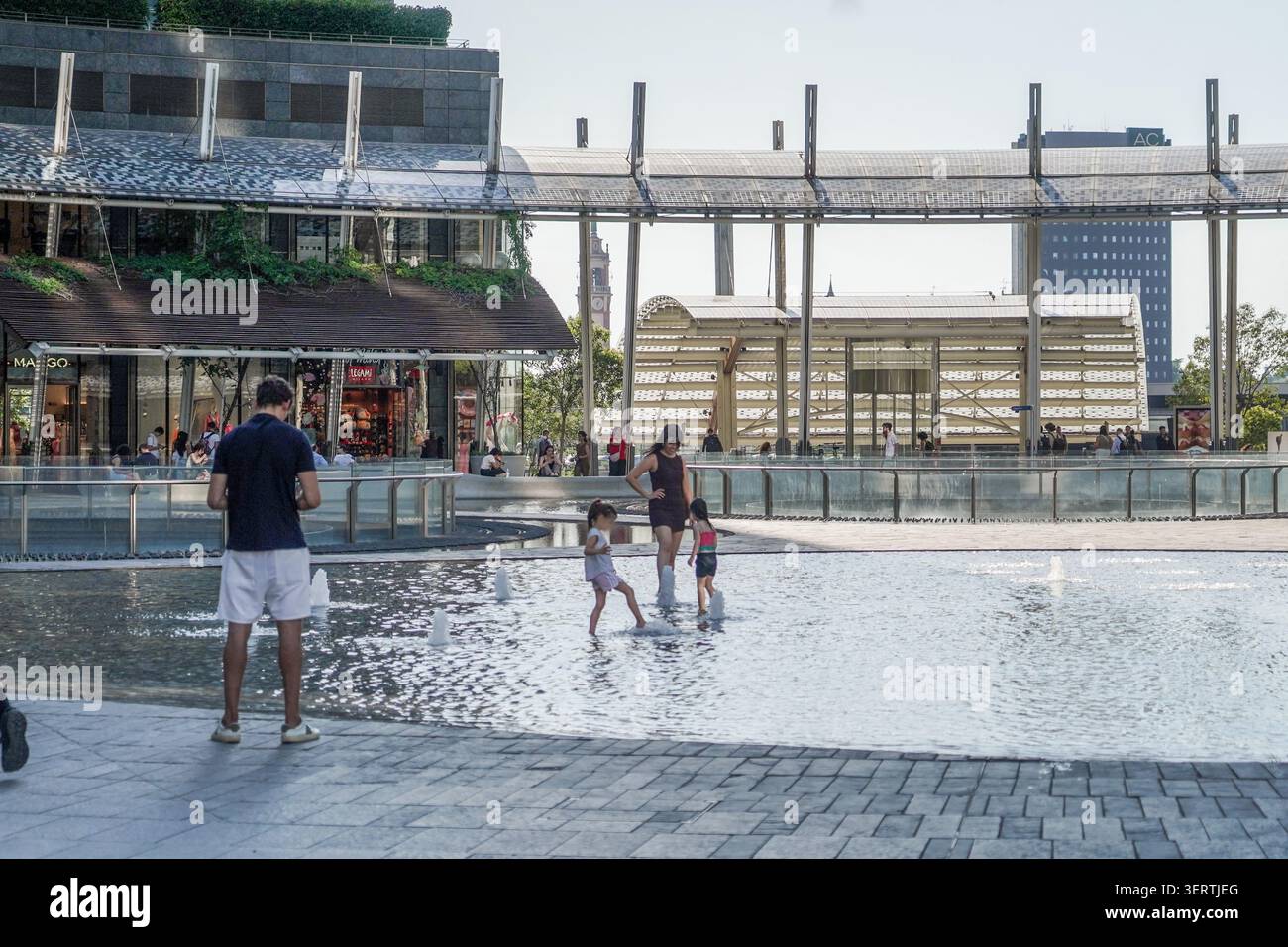 IPA85859516 - MILAN, June 19, 2026 - People cool off in the fountain in ...