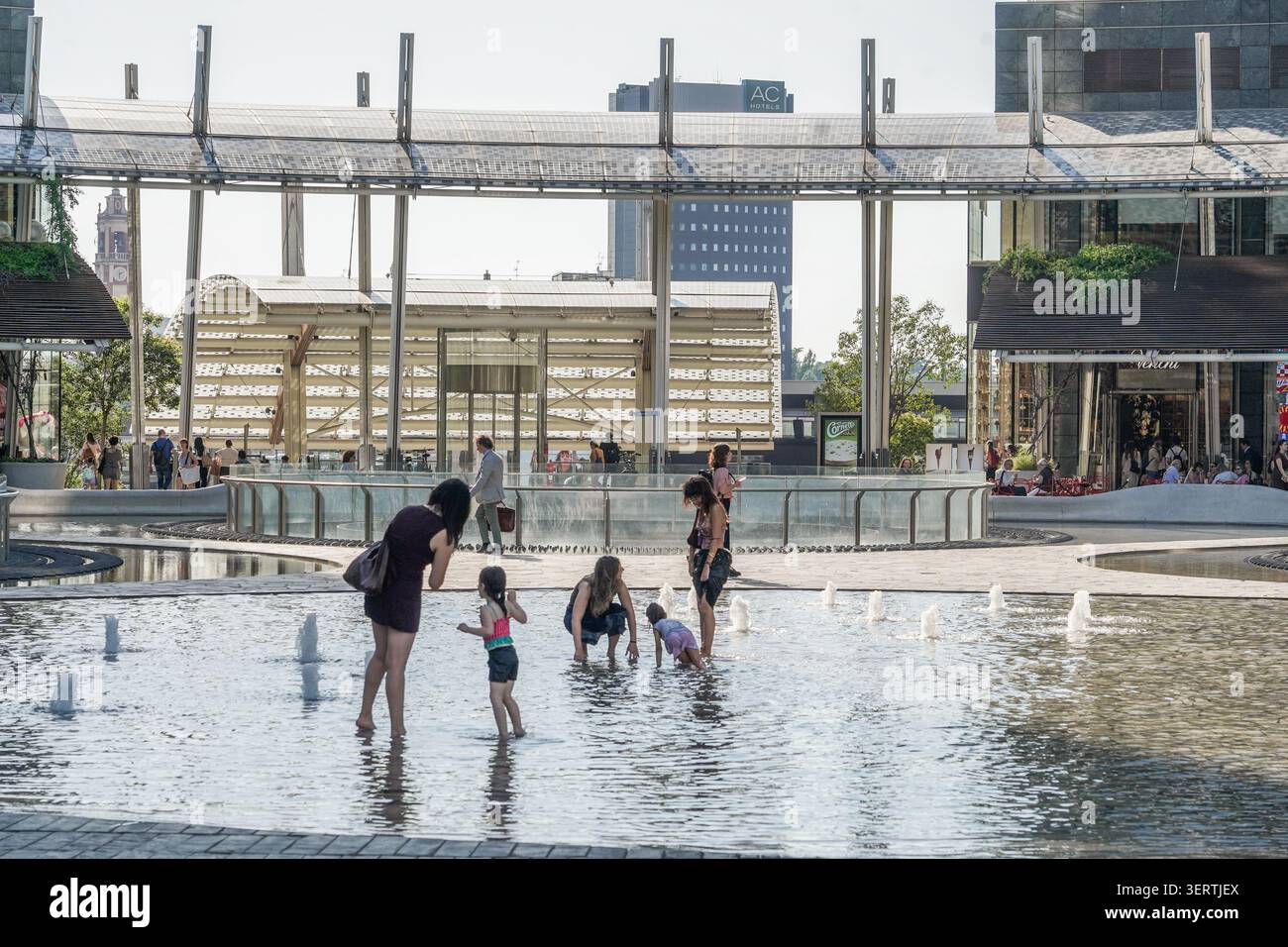 IPA85859521 - MILAN, June 19, 2026 - People cool off in the fountain in ...