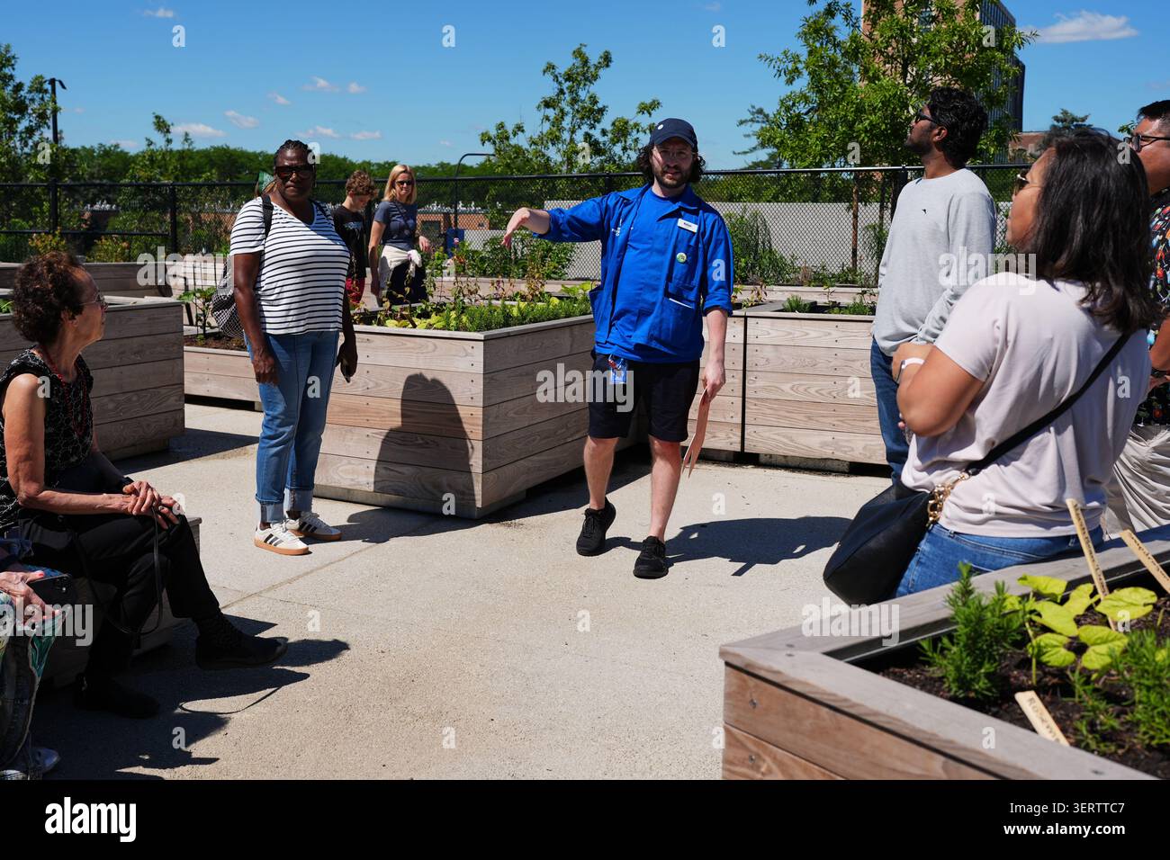 Nathan Michaelson talks with visitors in the Fruit and Vegetable Garden ...
