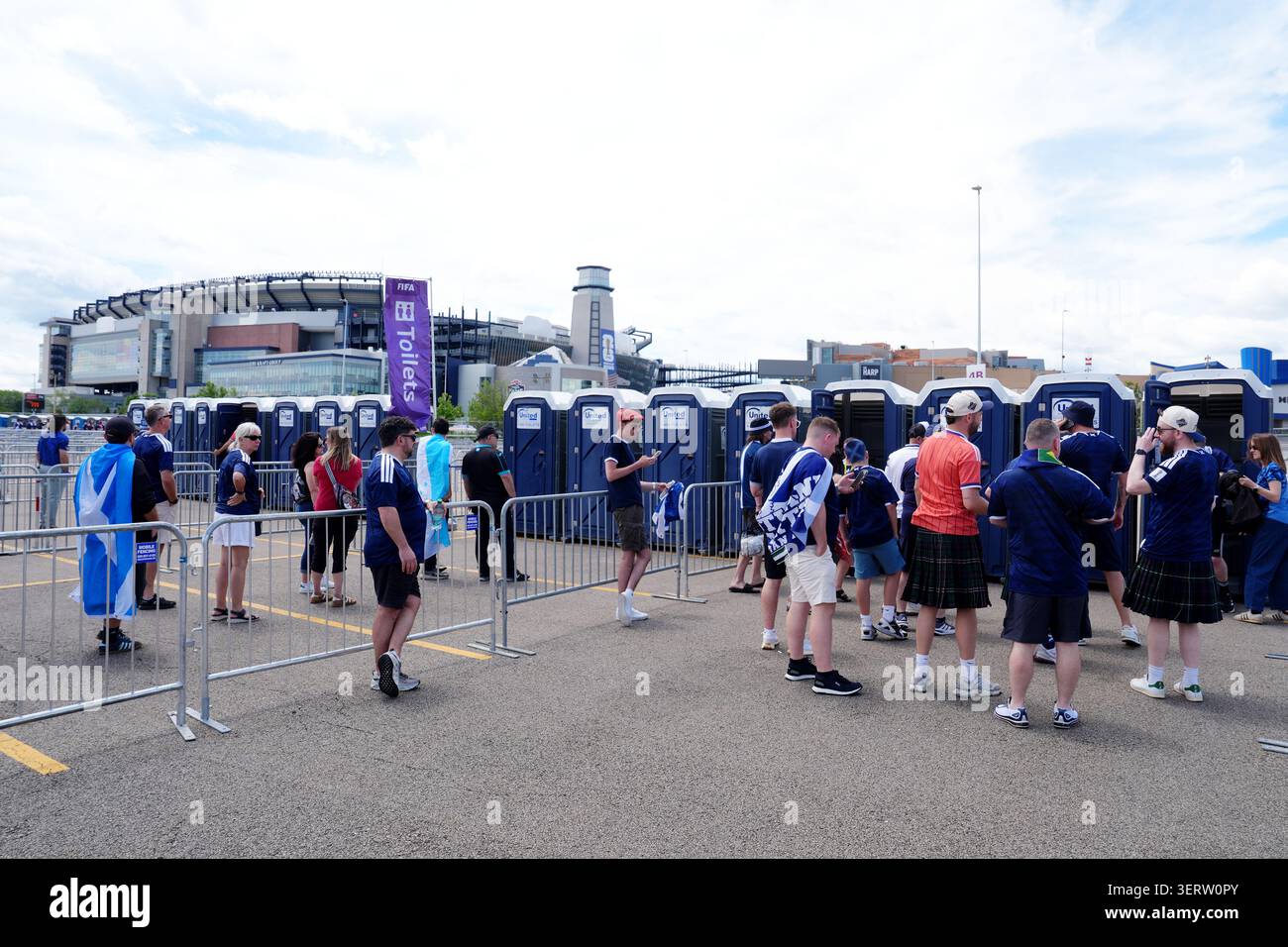 Scotland fans queue for the portable toilets outside the Boston Stadium ...