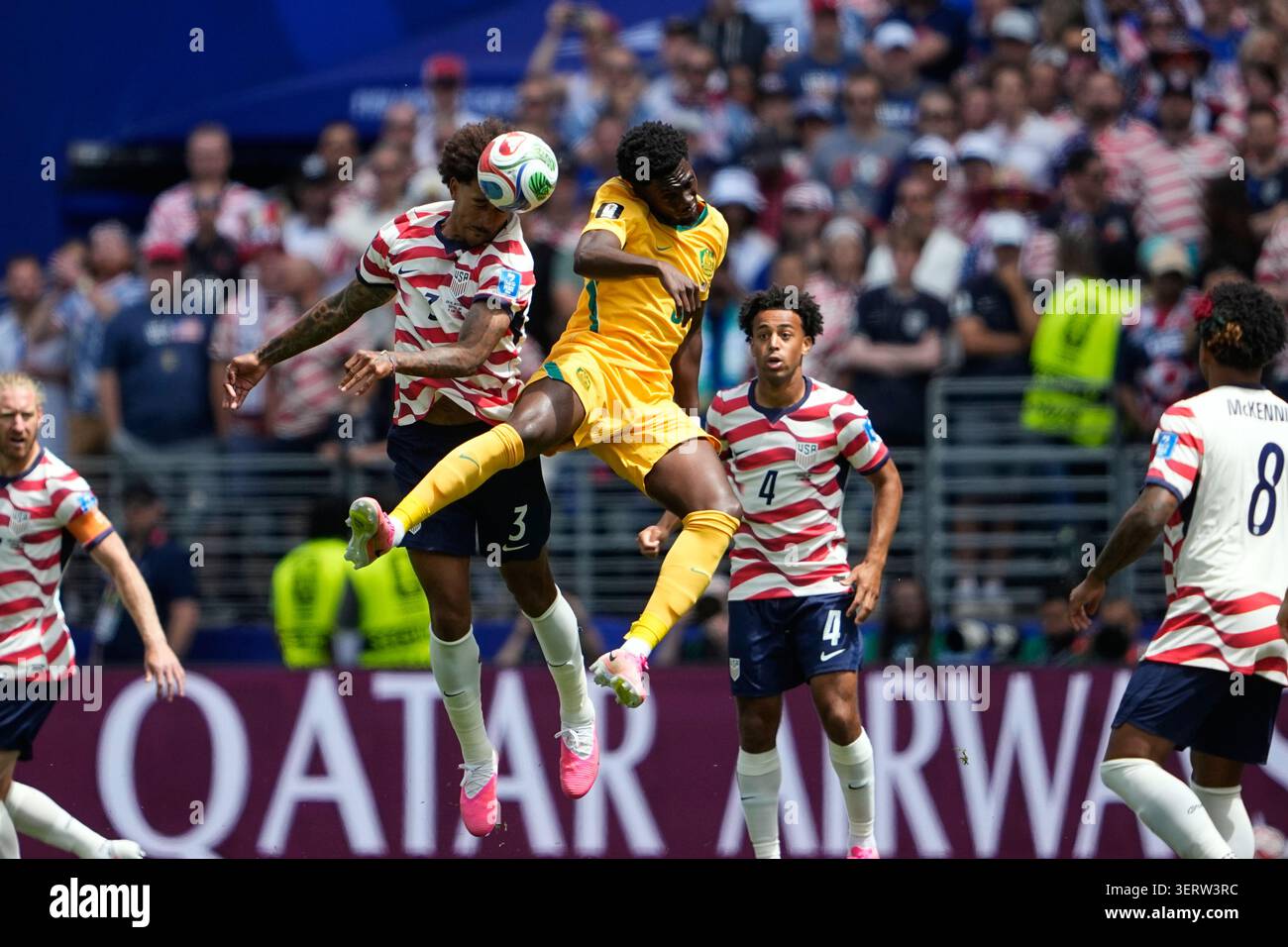Australia's Mohamed Toure jumps for the ball with United States' Chris ...