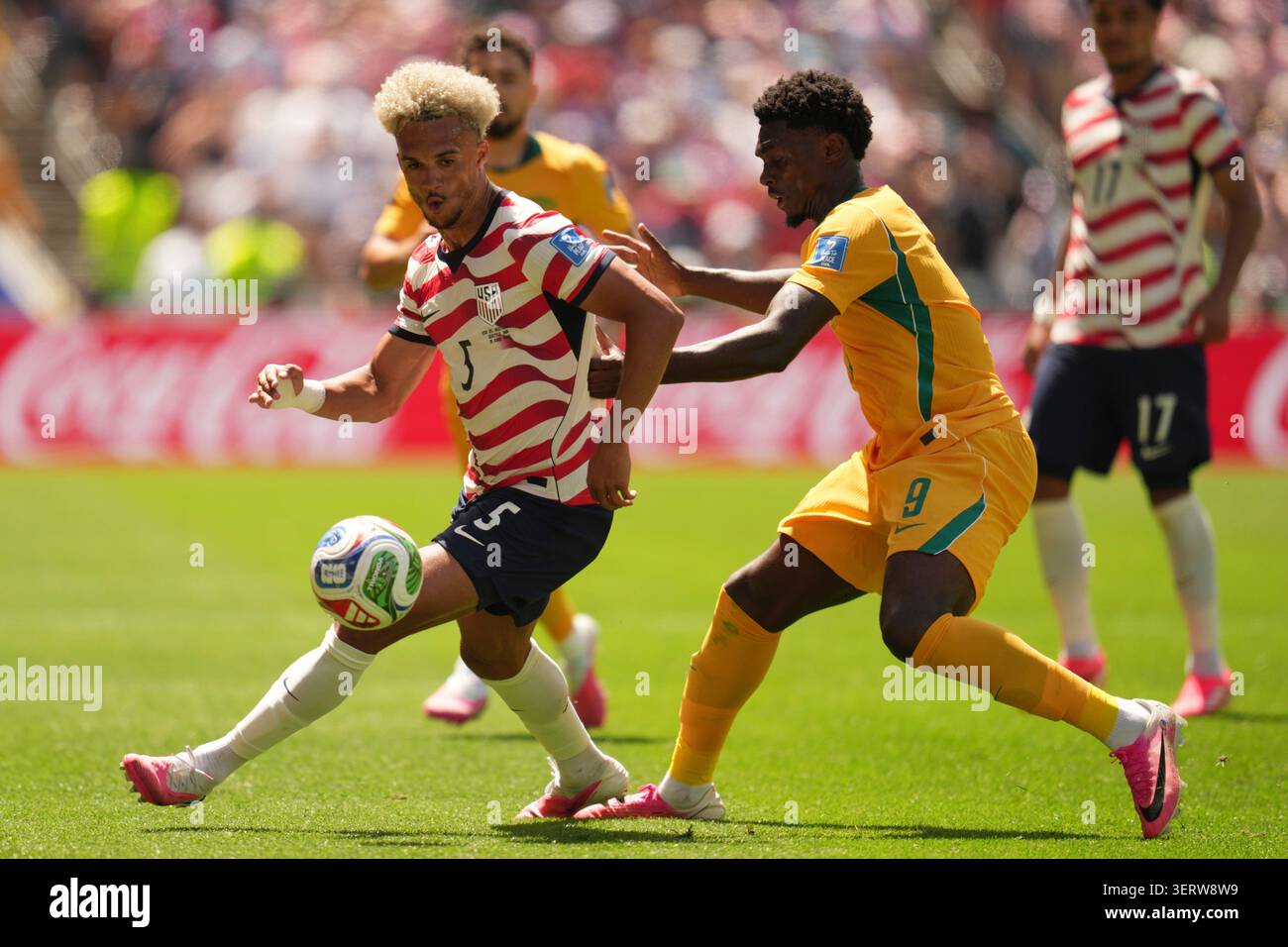 Australia's Mohamed Toure (9) tries to stop United States' Antonee ...