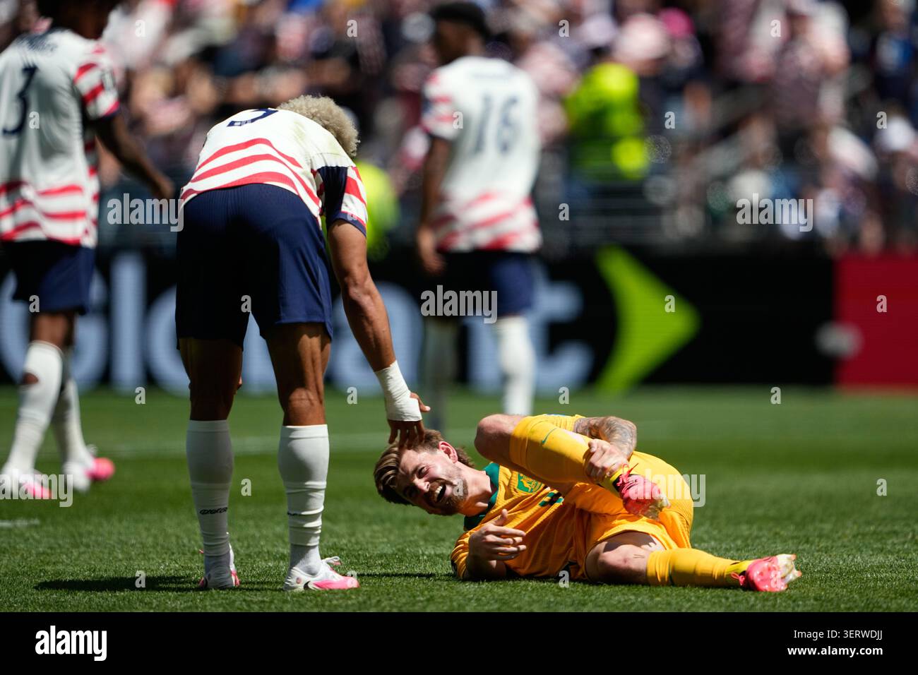 Australia's Connor Metcalfe grimaces after falling in the box during ...