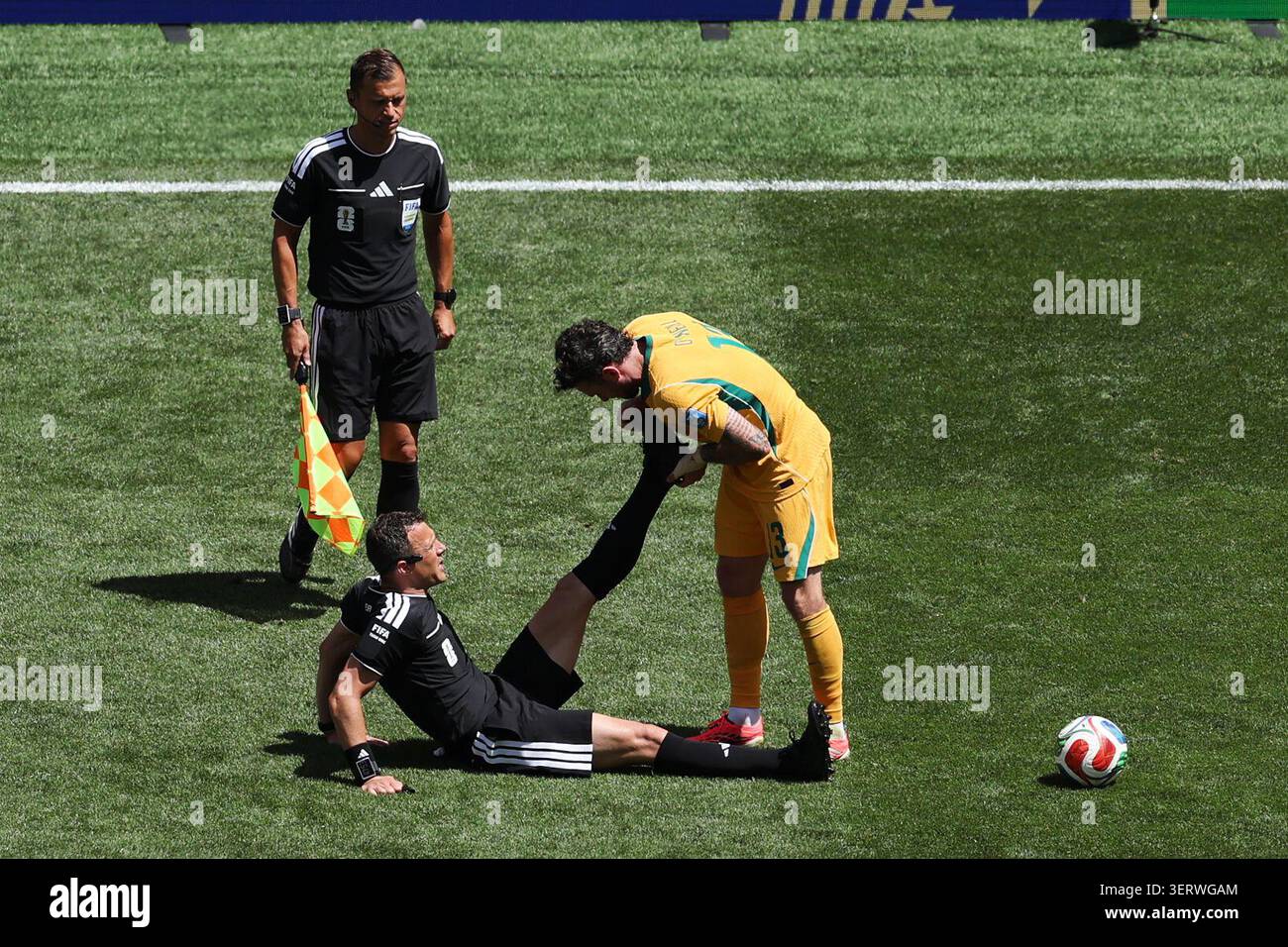 Referee Felix Zwayer, of Germany, is helped with a leg cramp by ...