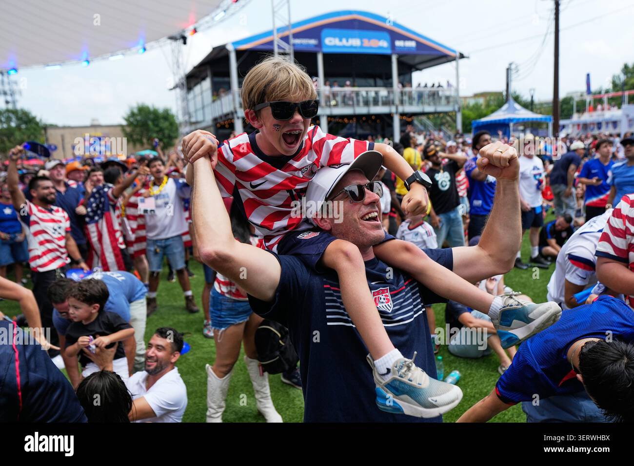 Russell Collins, 8, and Grayson Collins cheer while watching a live ...