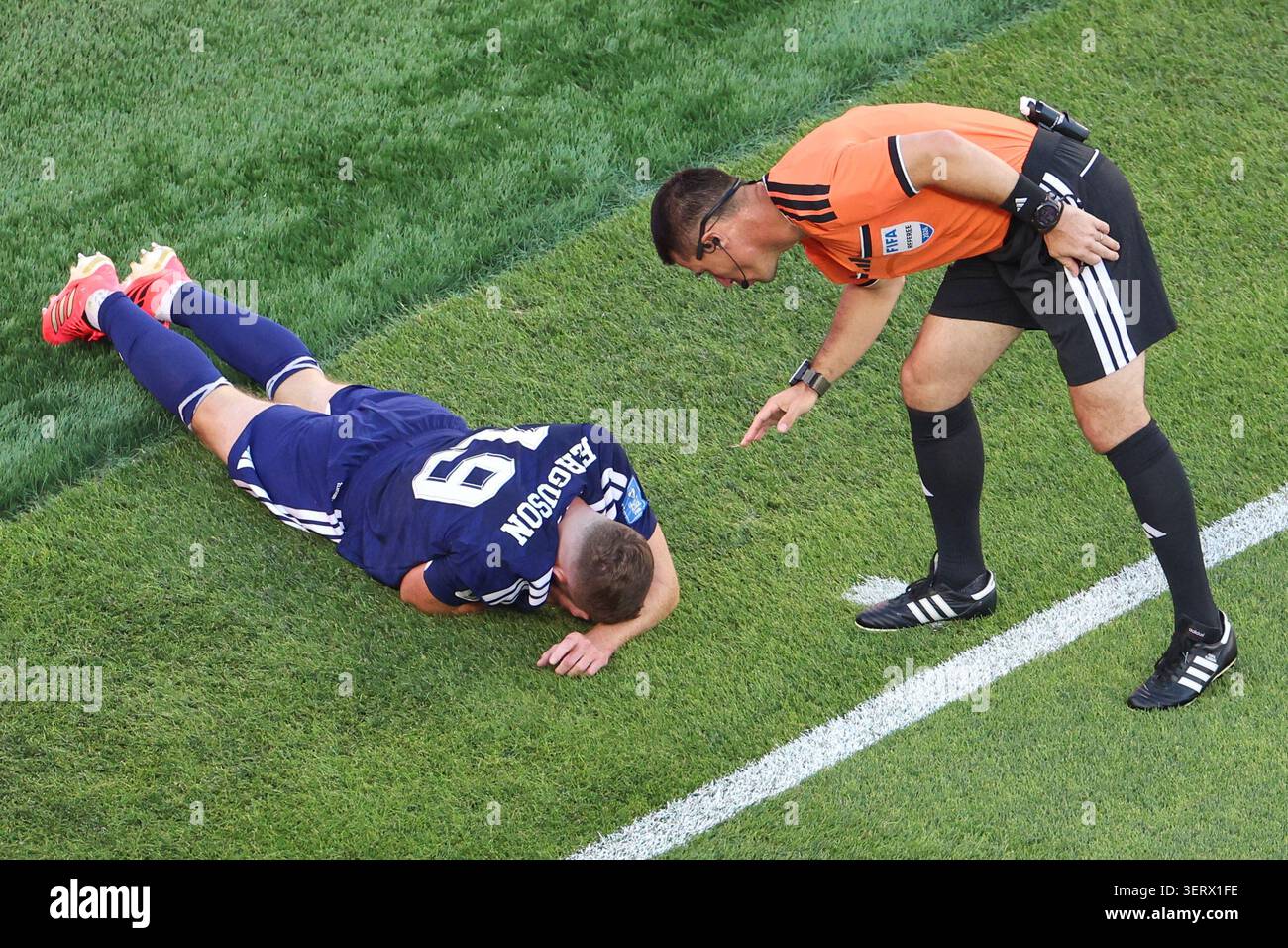 Referee Ilgiz Tantashev gestures to Scotland's Lewis Ferguson (19 ...