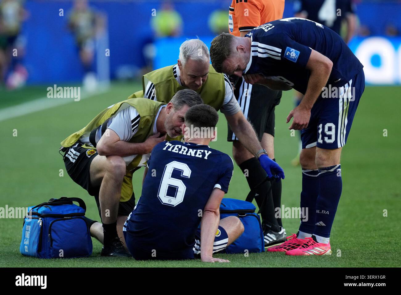 Scotland's Kieran Tierney is treated by medical staff after doing down ...