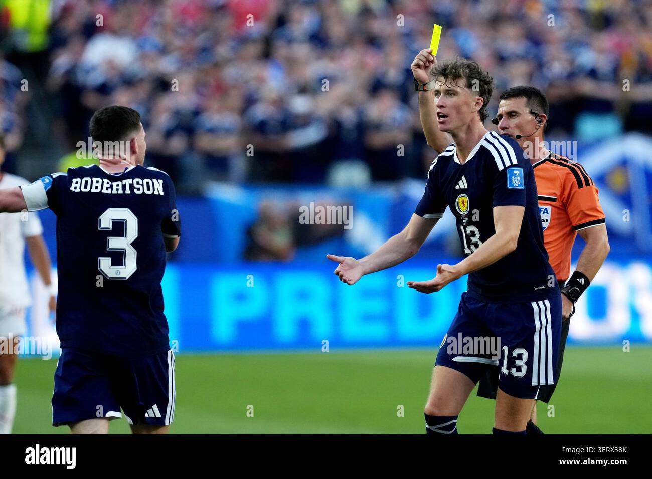 Scotland's Andrew Robertson (left) is shown a yellow card by referee ...