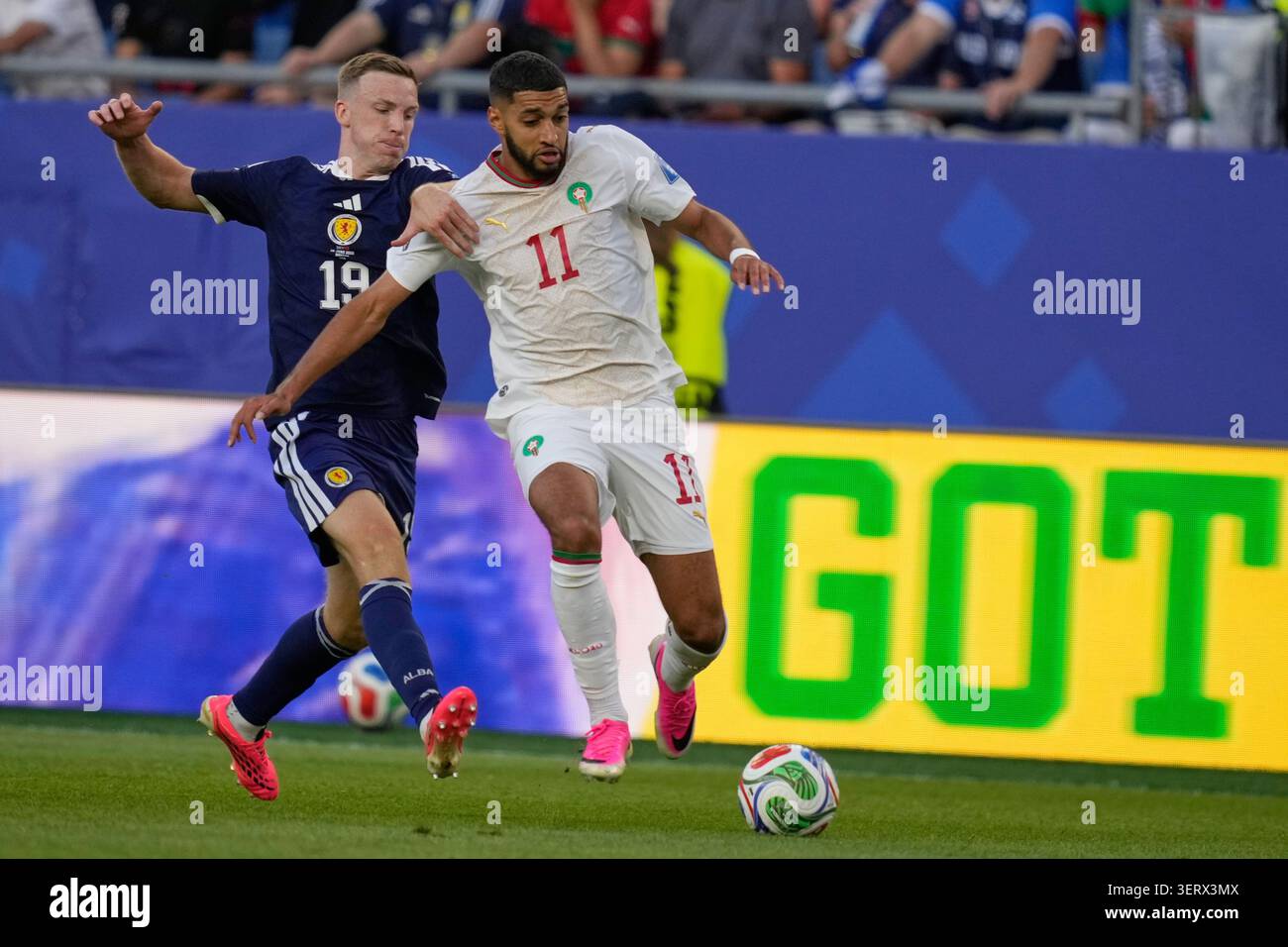 Scotland's Lewis Ferguson, left ,tackles Morocco's Ismael Saibari ...