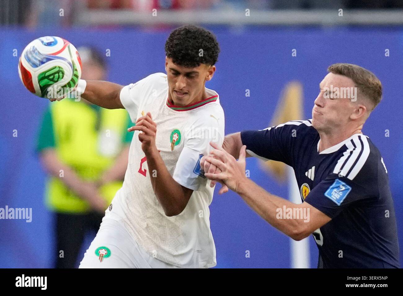 Morocco's Ayoub Amaimouni, left, depends the ball from Scotland's Lewis ...