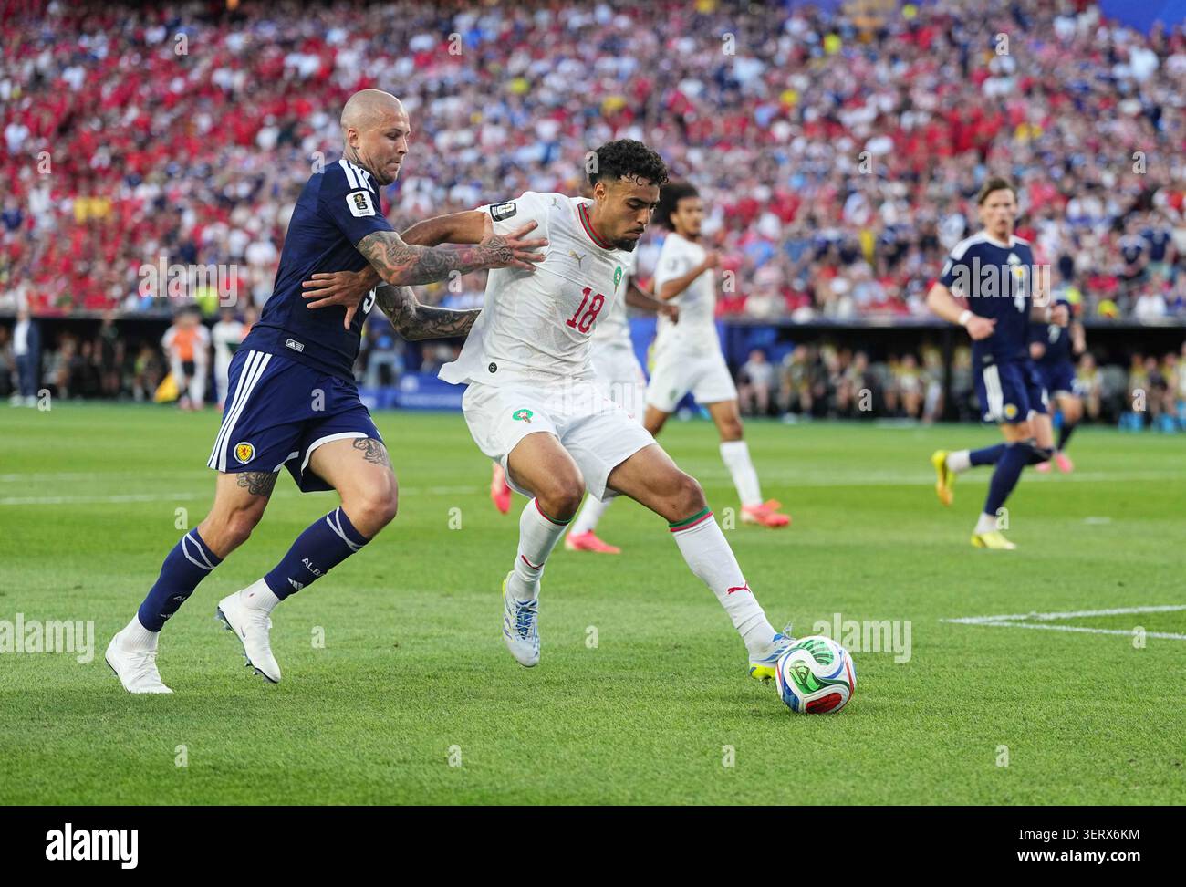 Chadi Riad (Morocco) and Lyndon Dykes (Scotland) battle for the ball ...