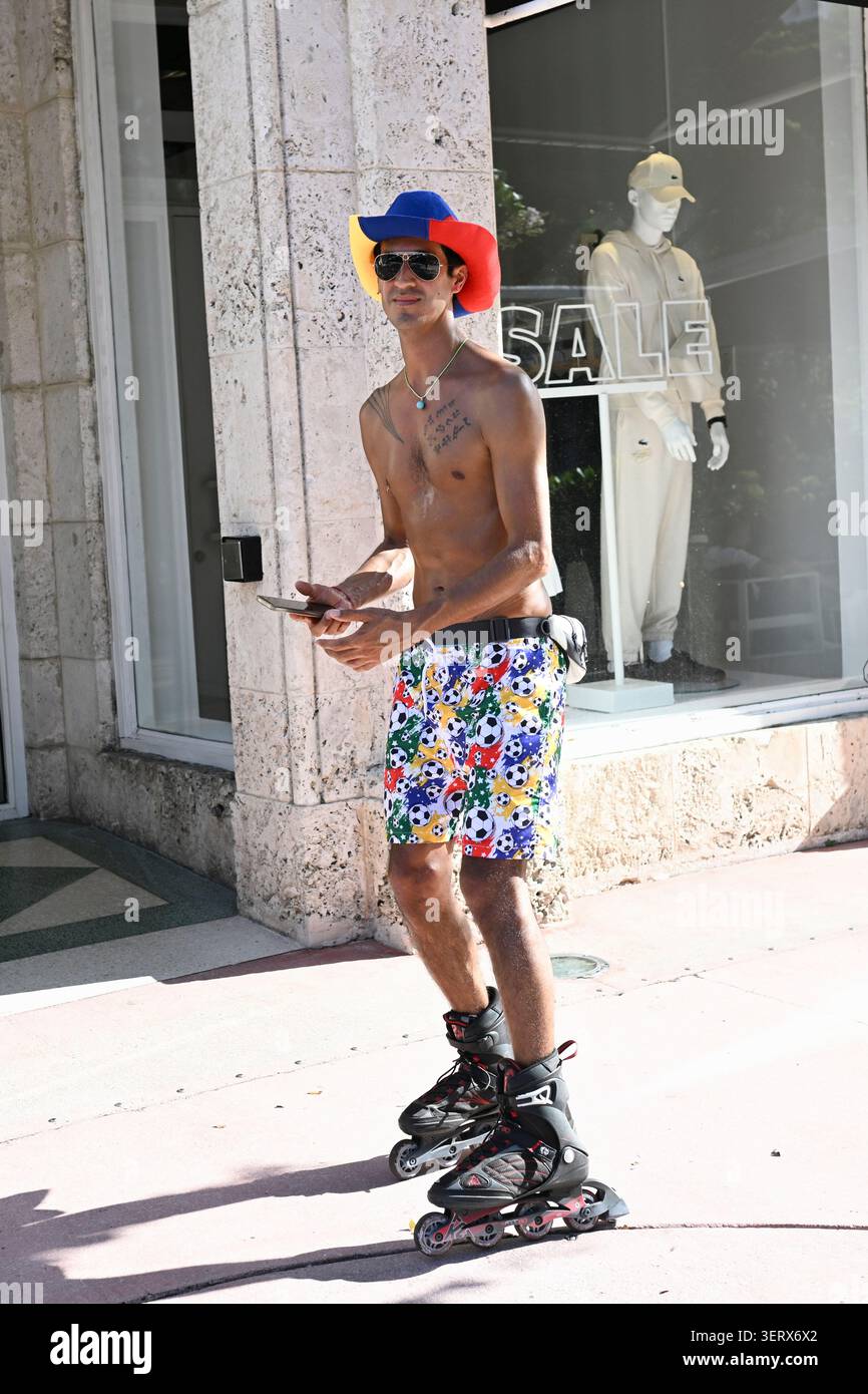 A man is seen wearing shorts with a soccer ball pattern, while ...