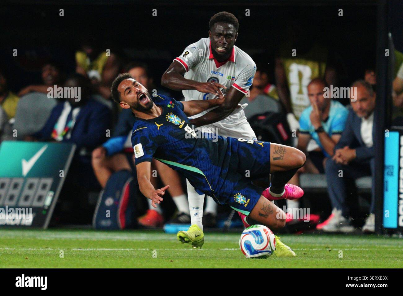 Brazil's Matheus Cunha (9) is tackled by Haiti's Carlens Arcus (2 ...