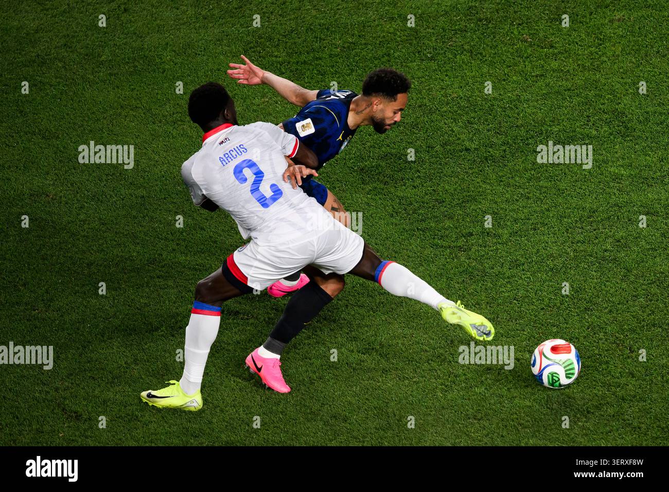 Matheus Cunha of Brazil comeptes for the ball with Carlens Arcus of ...