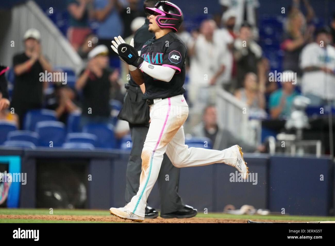Miami Marlins' Javier Sanoja scores on a sacrifice fly hit by Owen ...