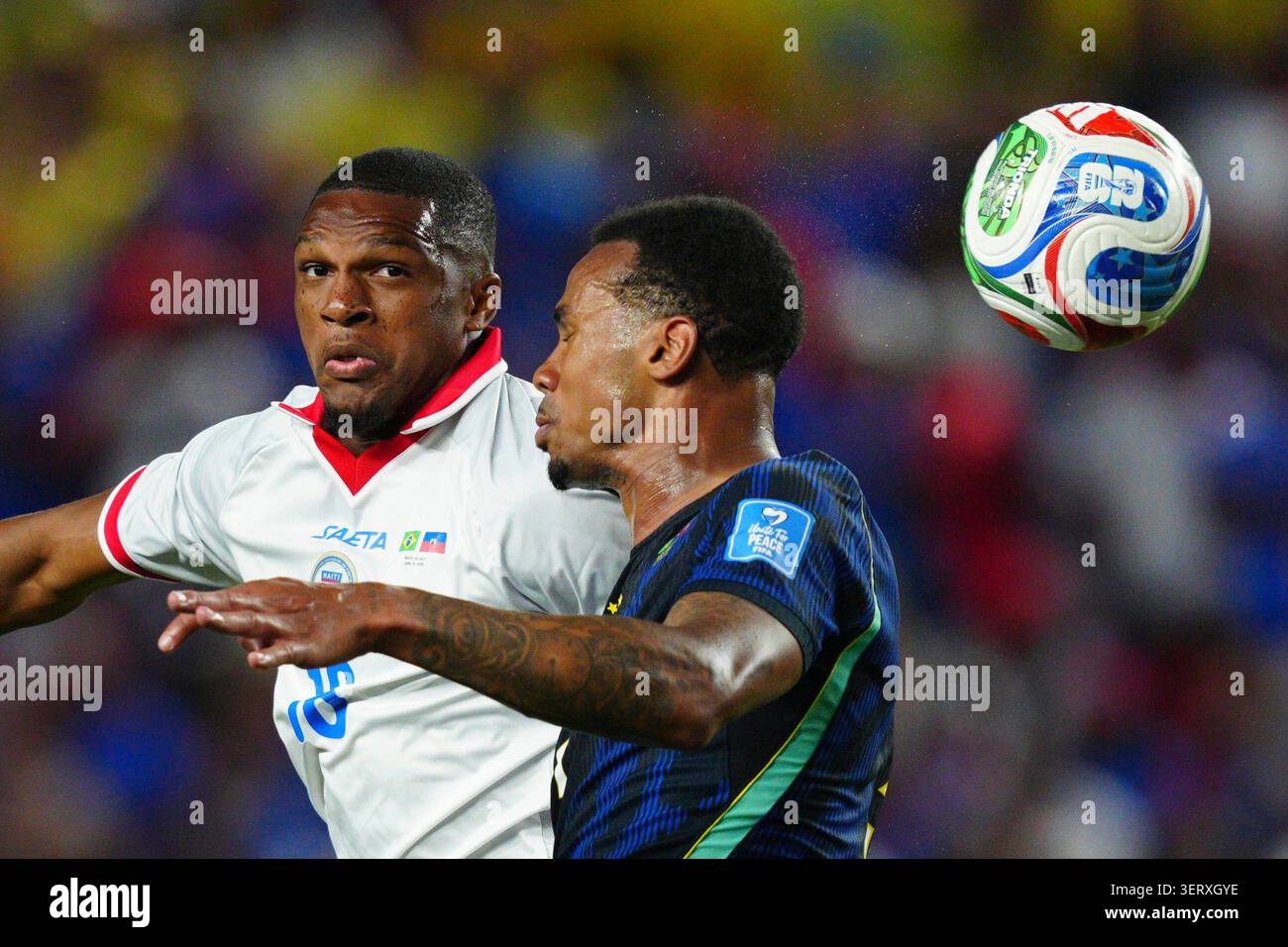 Brazil's Douglas Santos, left, battles for a header with Brazil's ...