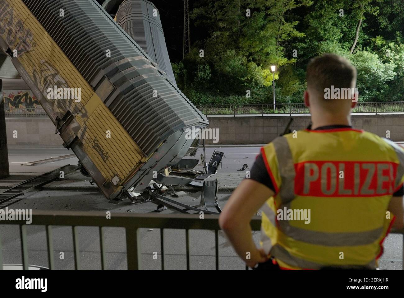 20 June 2026, Bavaria, Munich: Two cars of a freight train are lying on ...