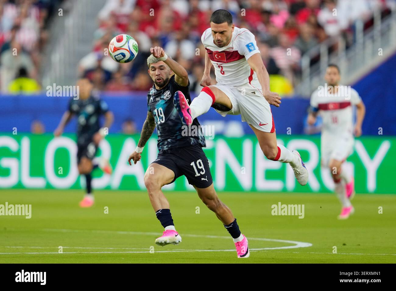Paraguay's Julio Enciso (19) battles for the ball with Turkey's Merih ...