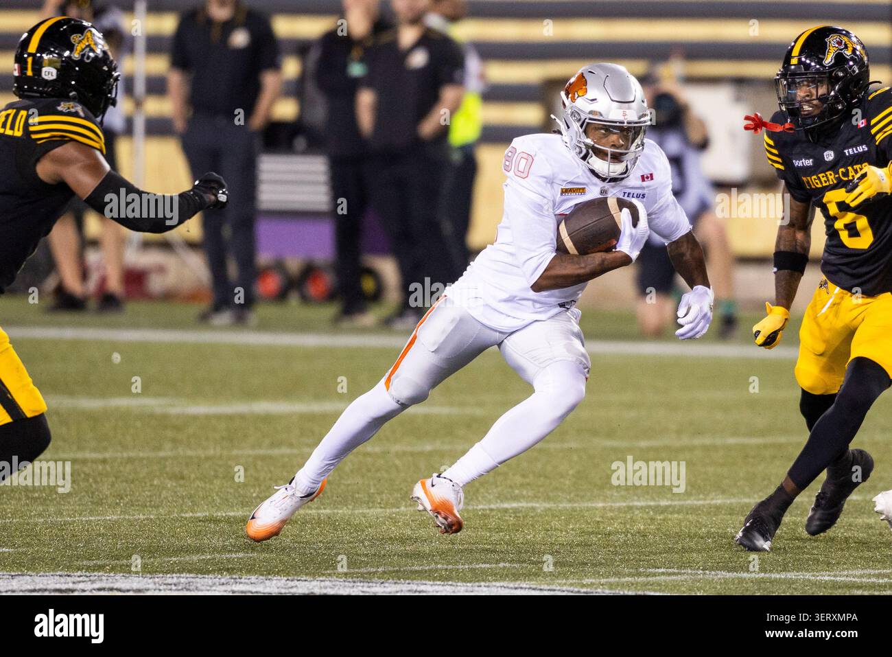 B.C. Lions' Jaden Williams (80) runs the ball past Hamilton Tiger-Cats ...