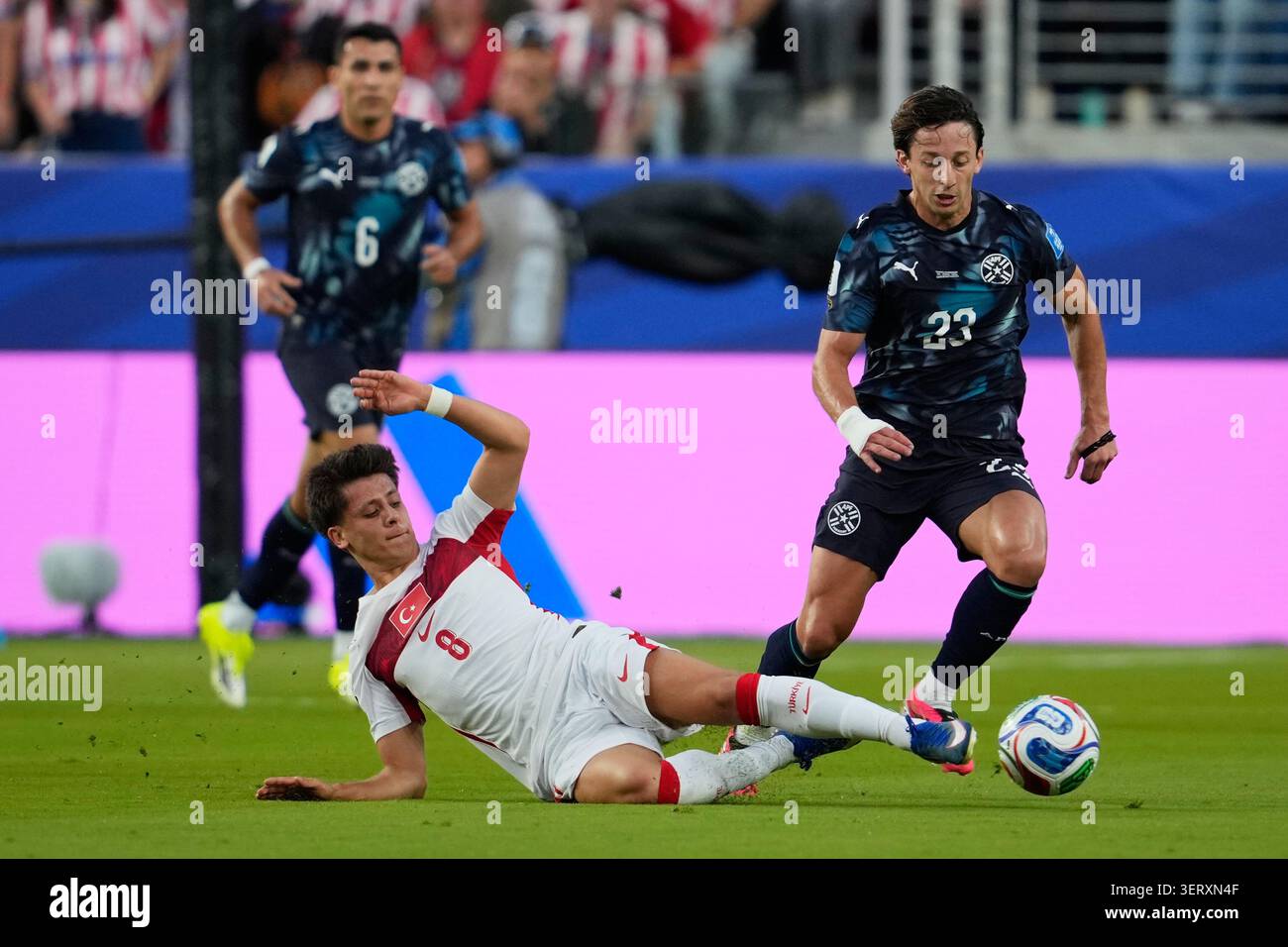 Paraguay's Matias Galarza (23) battles for the ball with Turkey's Arda ...
