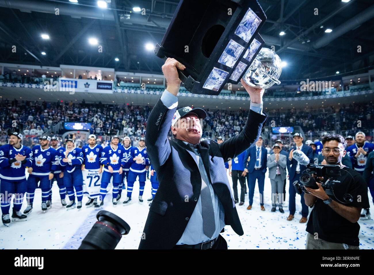 Toronto Marlies head coach John Gruden, center, hoists the Calder Cup ...