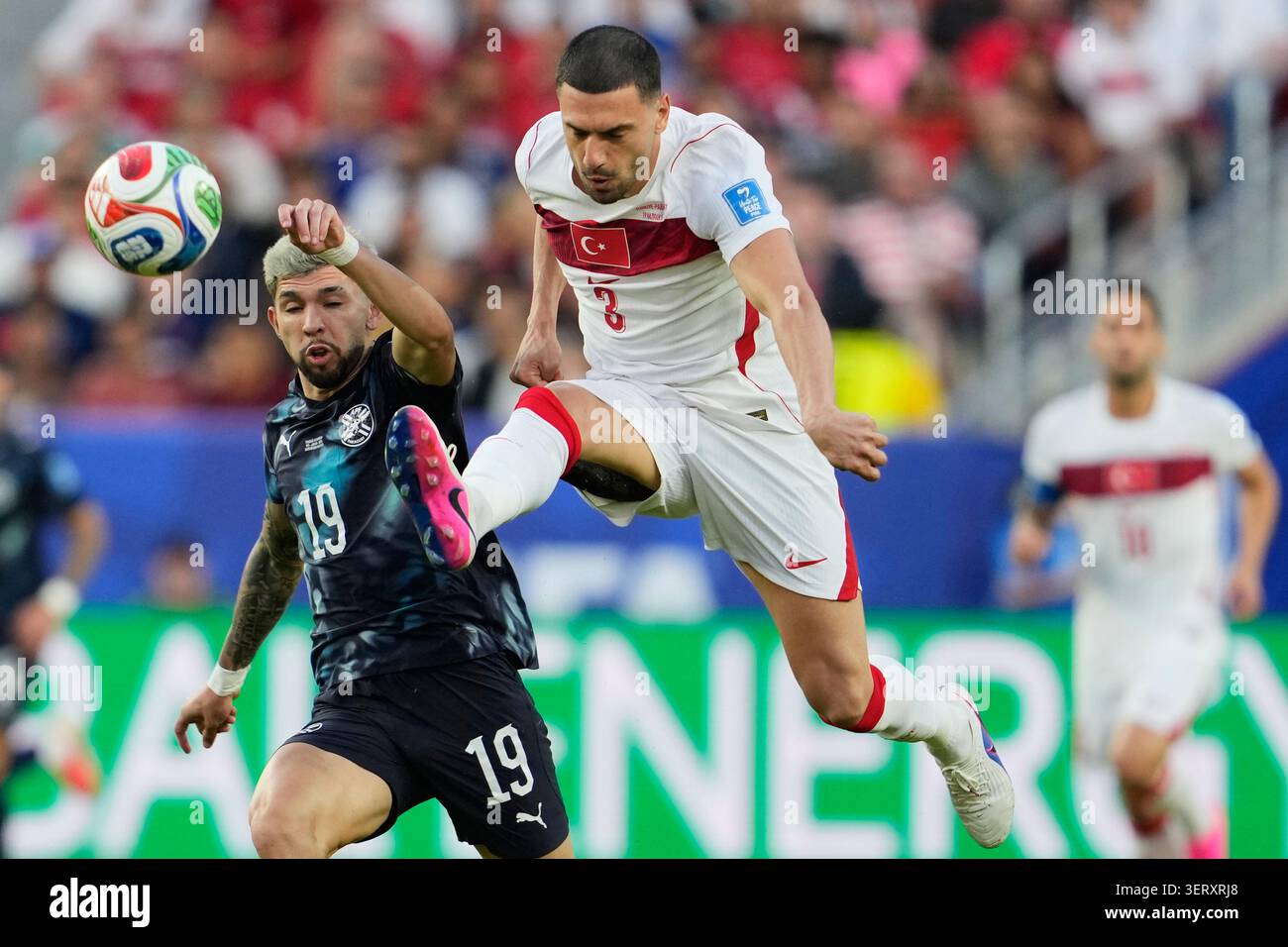 Paraguay's Julio Enciso (19) battles for the ball with Turkey's Merih ...