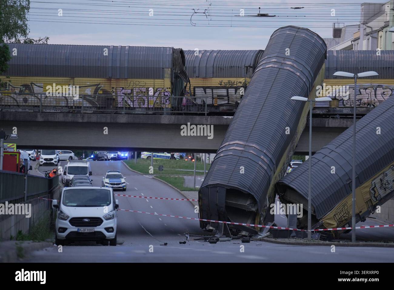 20 June 2026, Bavaria, Munich: Two cars of a freight train are lying on ...
