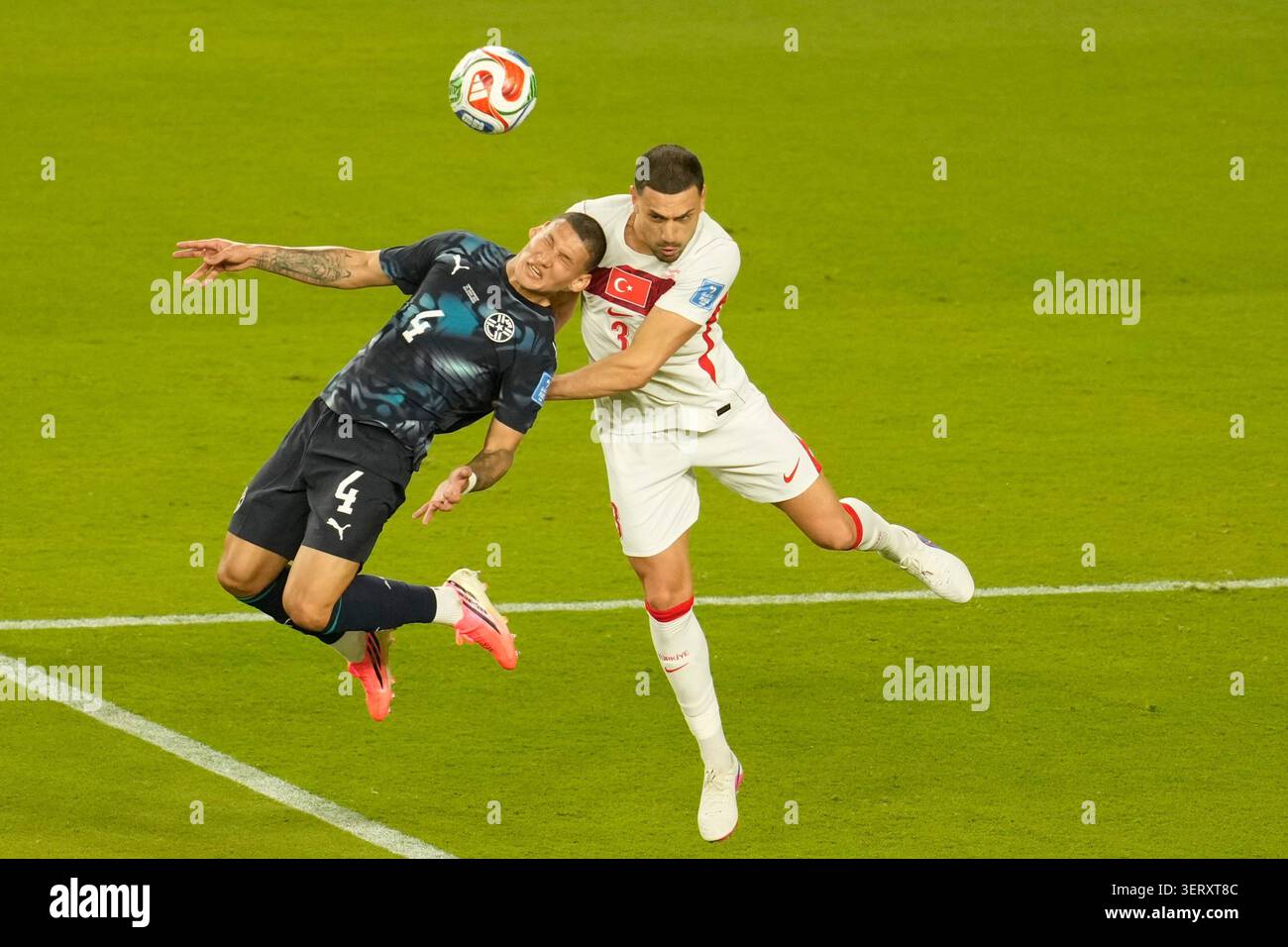Paraguay's Juan Jose Caceres, left, heard a ball next to Turkey's Merih ...