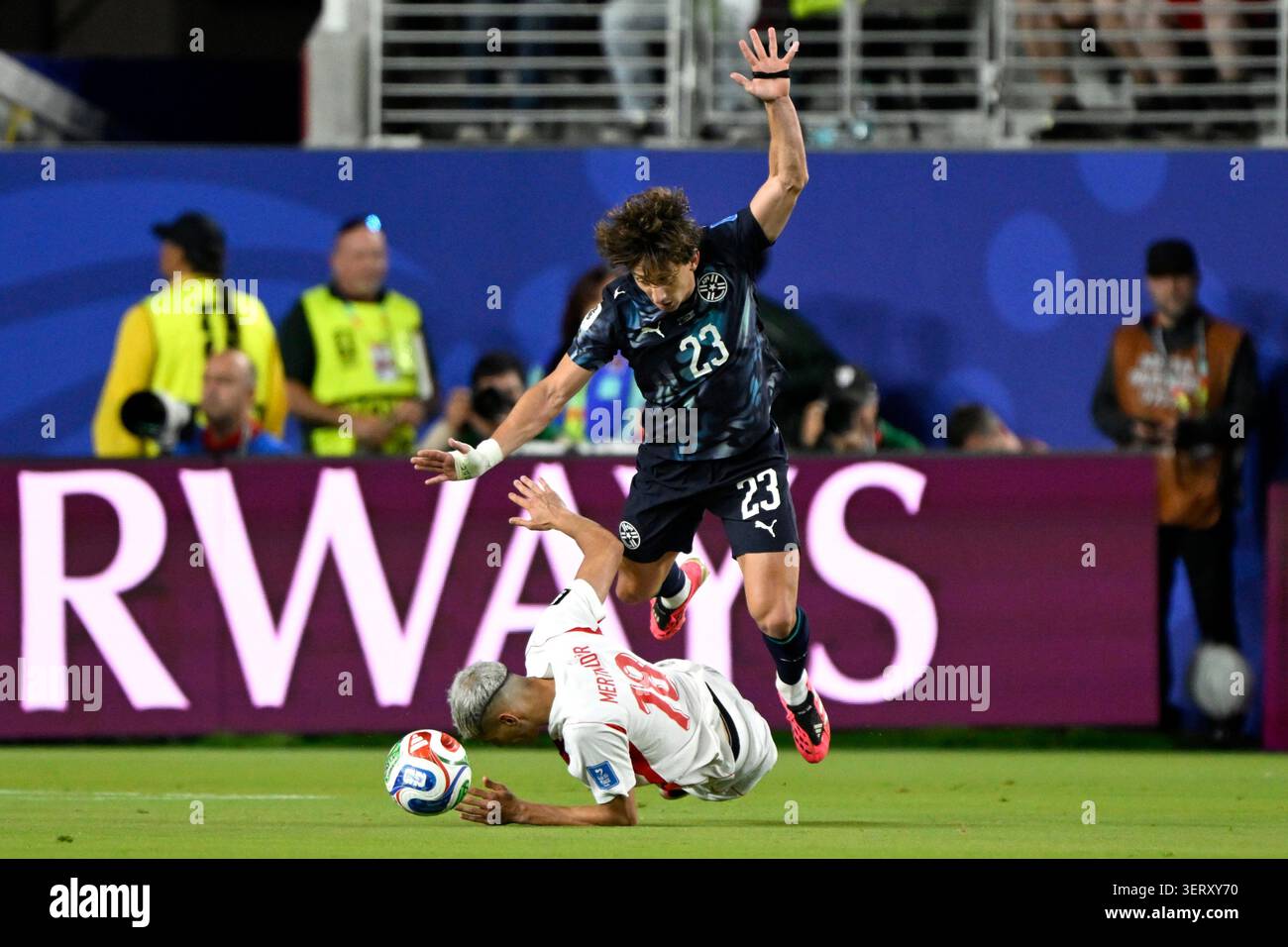 Turkey's Mert Muldur (18) challenges for the ball with Paraguay's ...